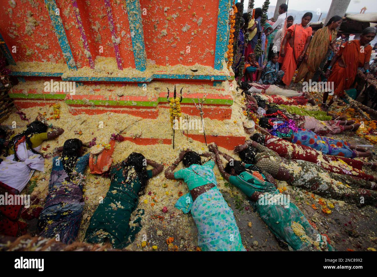 Indian Hindu women prostrate as they offer prayers at Lingamanthula ...