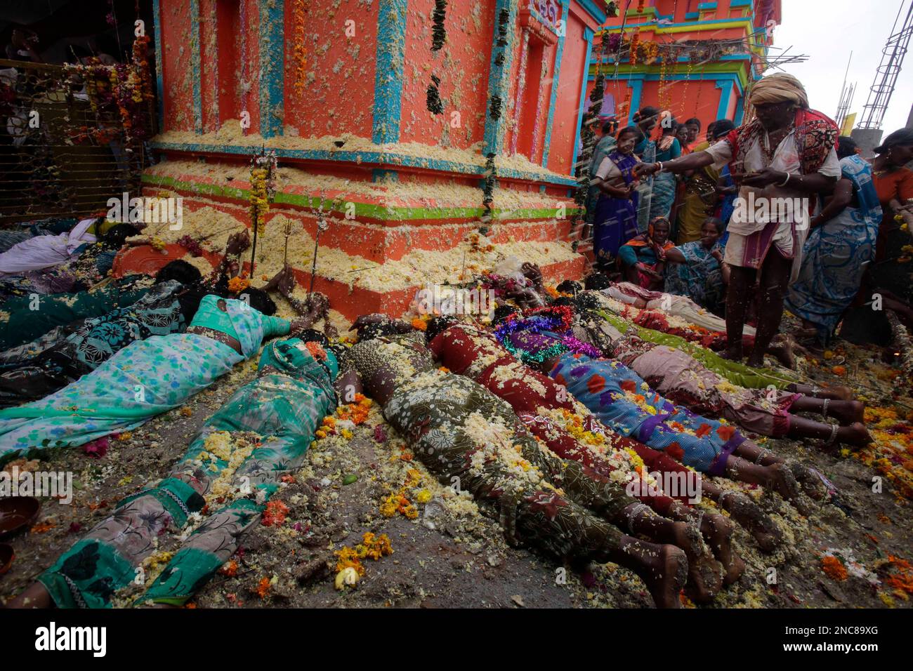 Indian Hindu women prostrate as they offer prayers at Lingamanthula ...