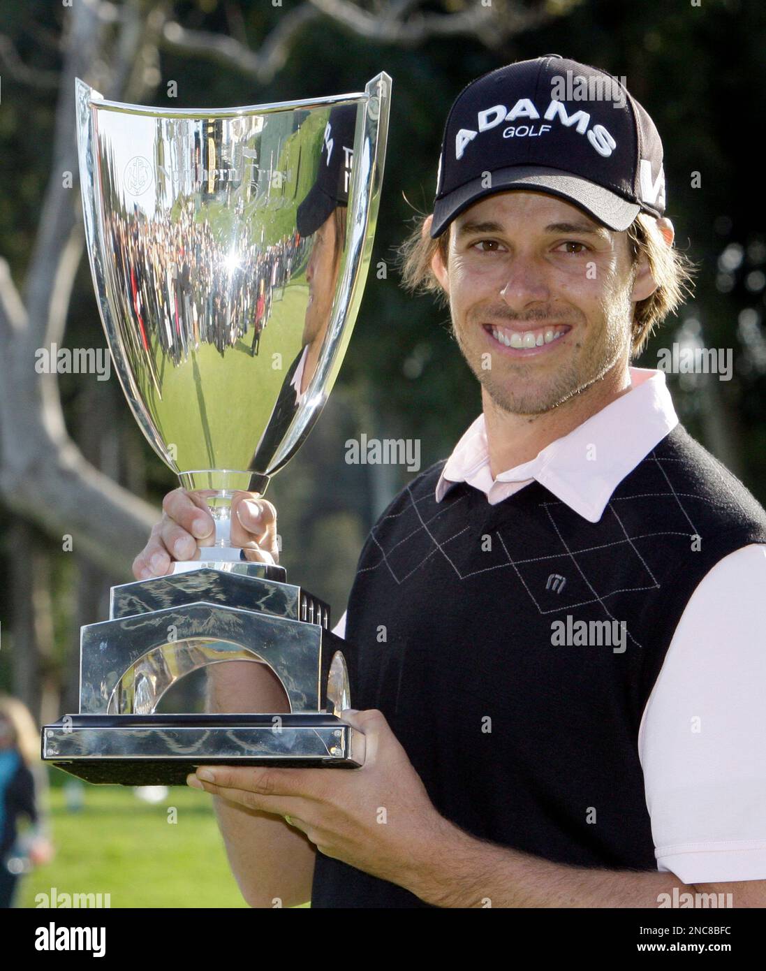 Aaron Baddeley, of Australia, holds the trophy after wining the ...