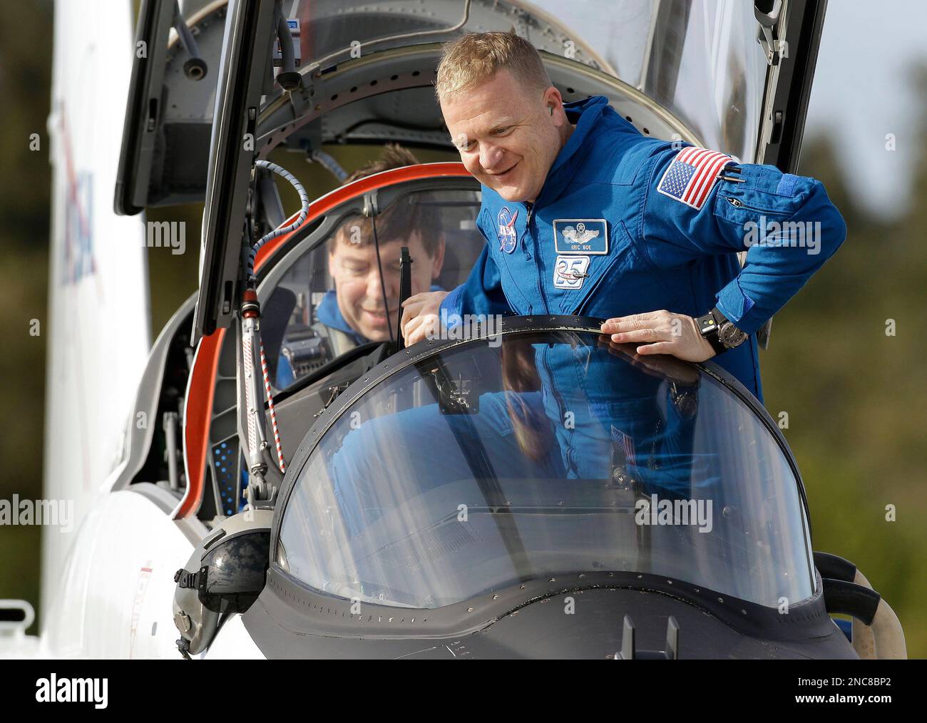 STS-133 pilot Eric Boe, front, and mission specialist Michael Barratt prepare to climb from ...
