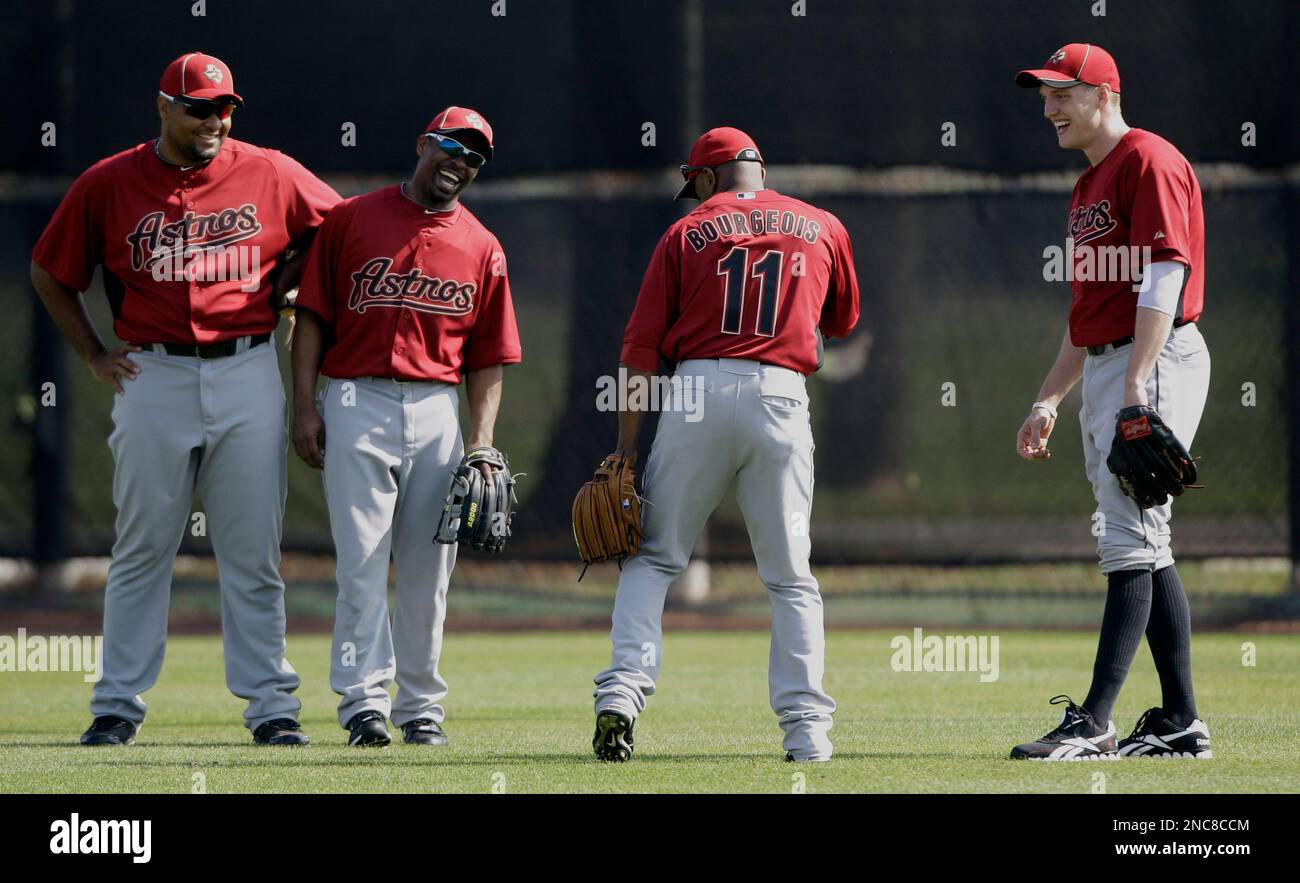Houston Astros outfielders, from left to right, Carlos Lee, Michael ...