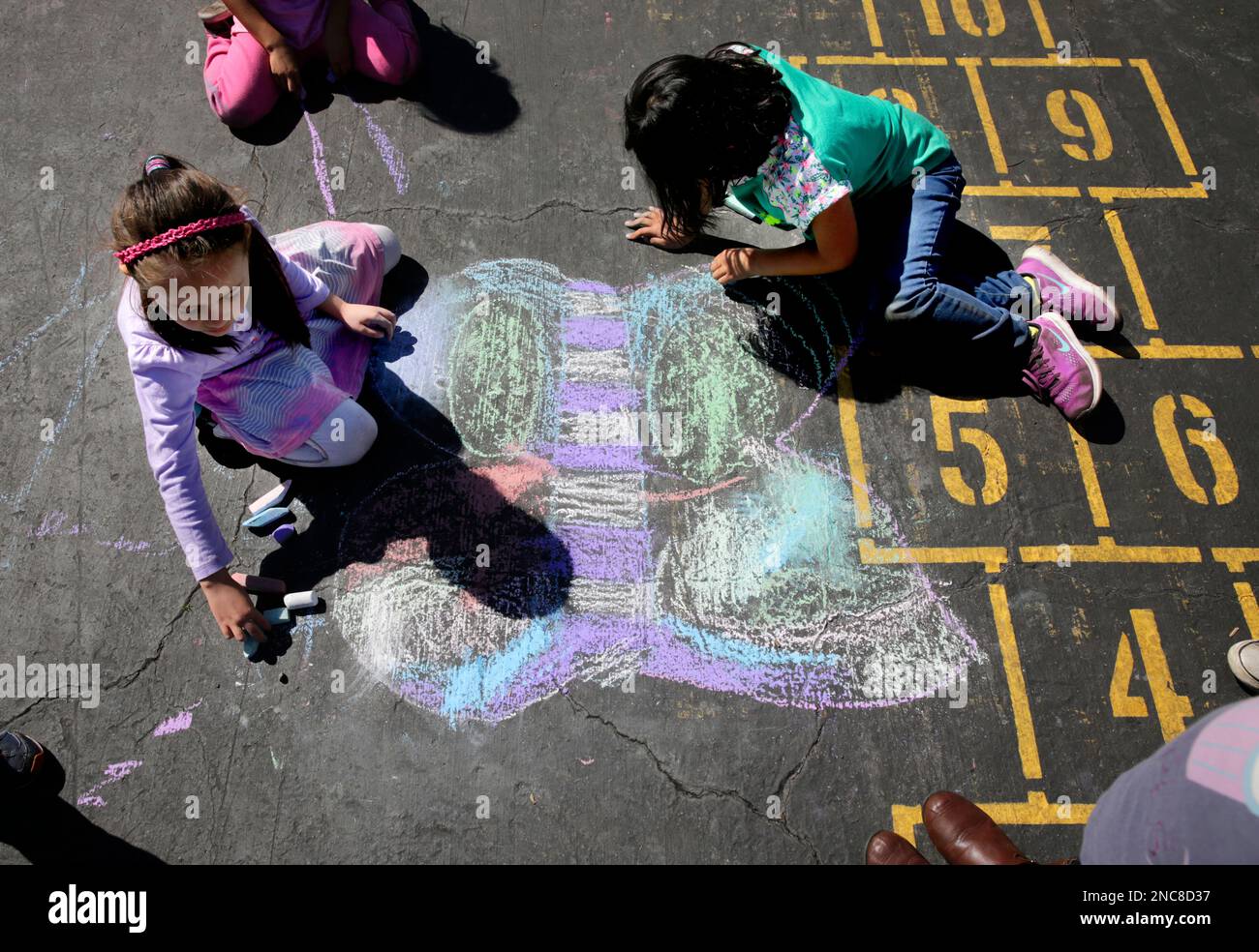 Alina Barascout, (left) and Molly Cho who are in kindergarten draw ...