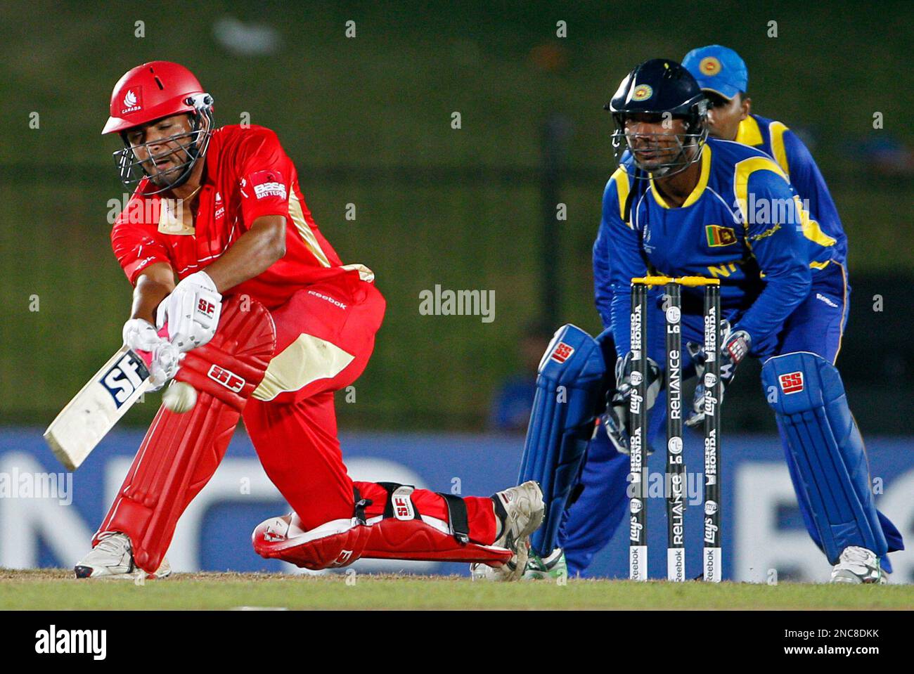 Canada's batsman Harvir Baidwan sweeps a delivery as Sri Lanka's ...
