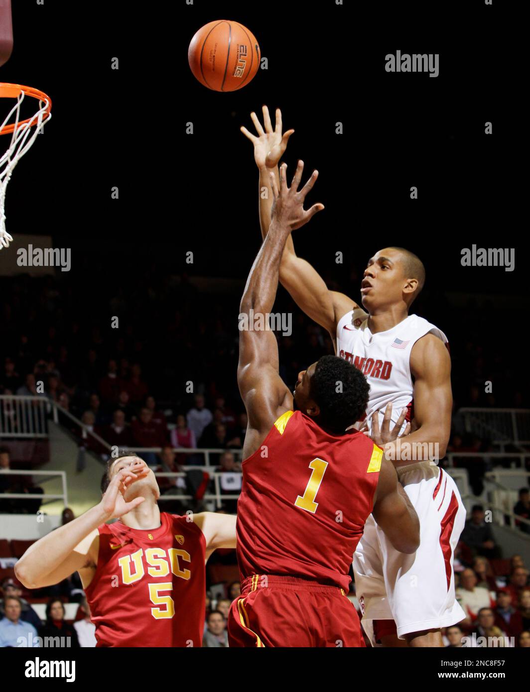 Stanford forward Josh Owens, right, goes up for two in front of ...