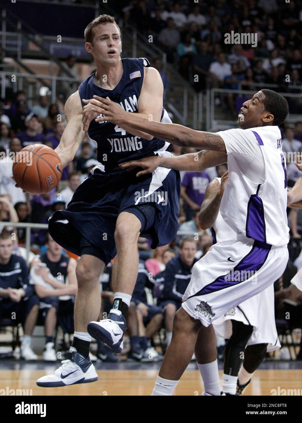 BYU guard Jackson Emery, left, passes the ball as TCU 's Jarvis Ray ...