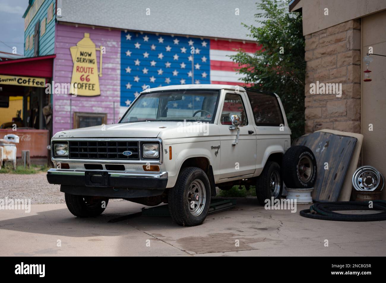An old white Ford Bronco third generation parked with the USA flag on ...