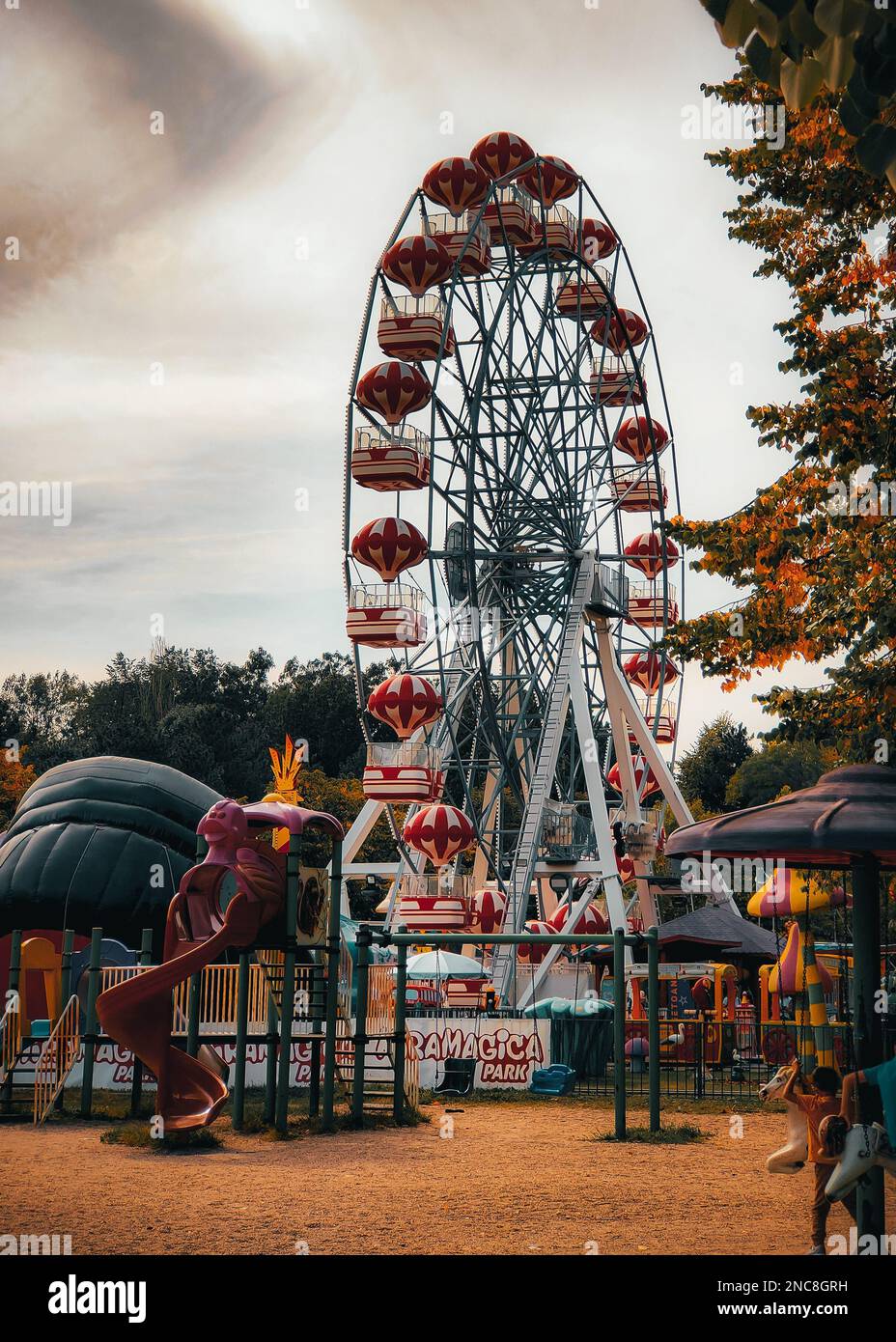 A vertical shot of a Ferris wheel in an amusement park in Bucharest ...