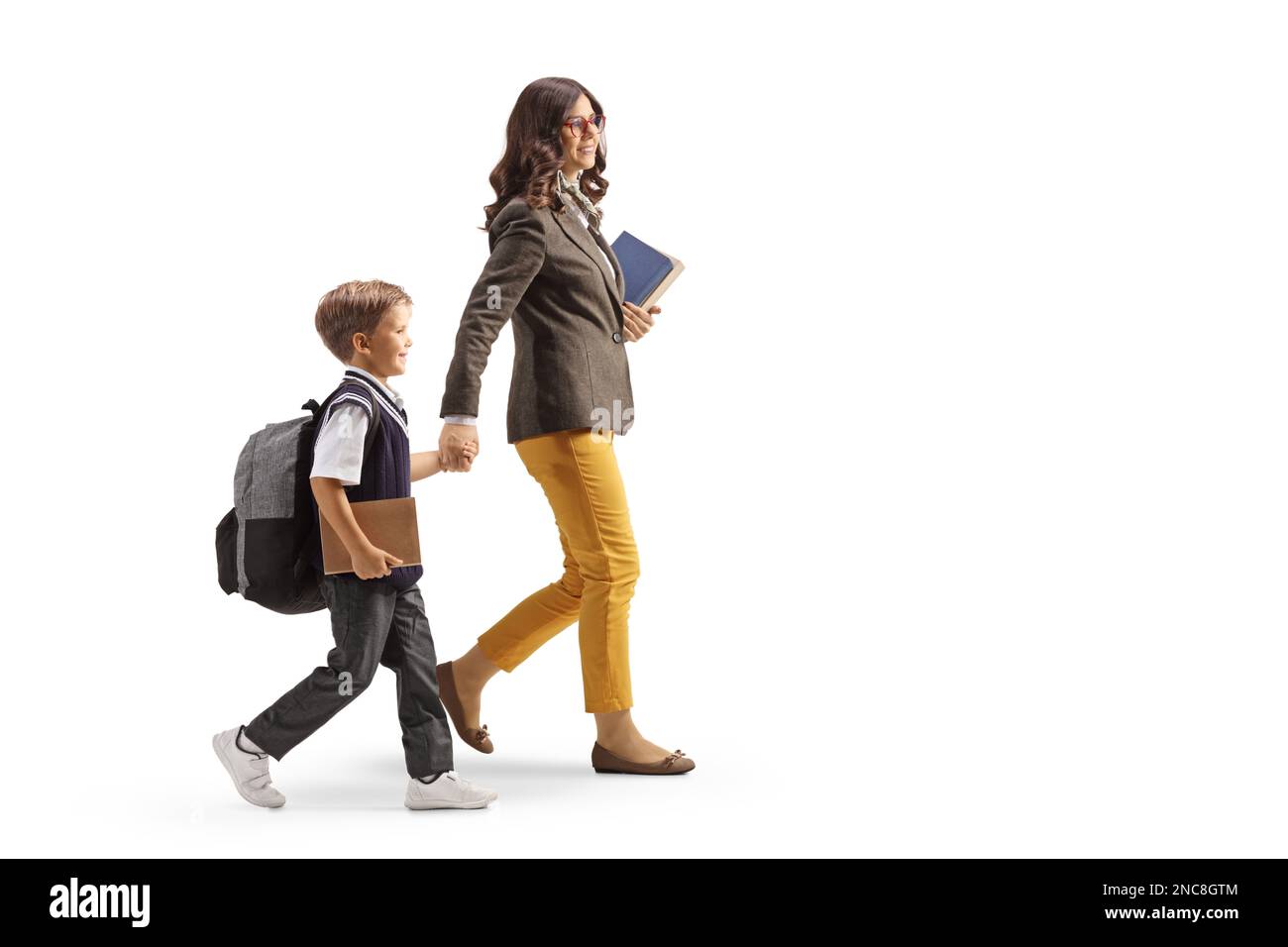 Full length profile shot of a teacher and a schoolboy walking and ...