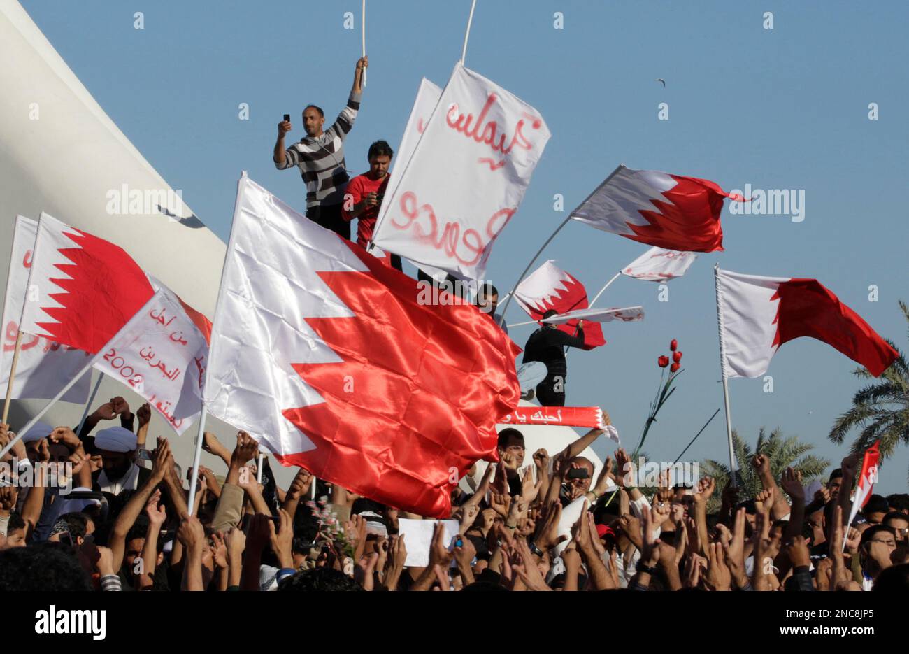 Bahraini protesters chant slogans at the Pearl roundabout soon after ...