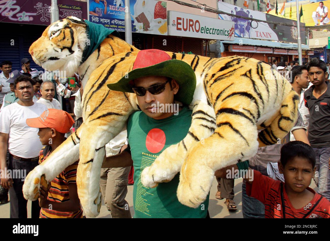 A Bangladeshi fan carries a toy tiger outside the opening match of the ...