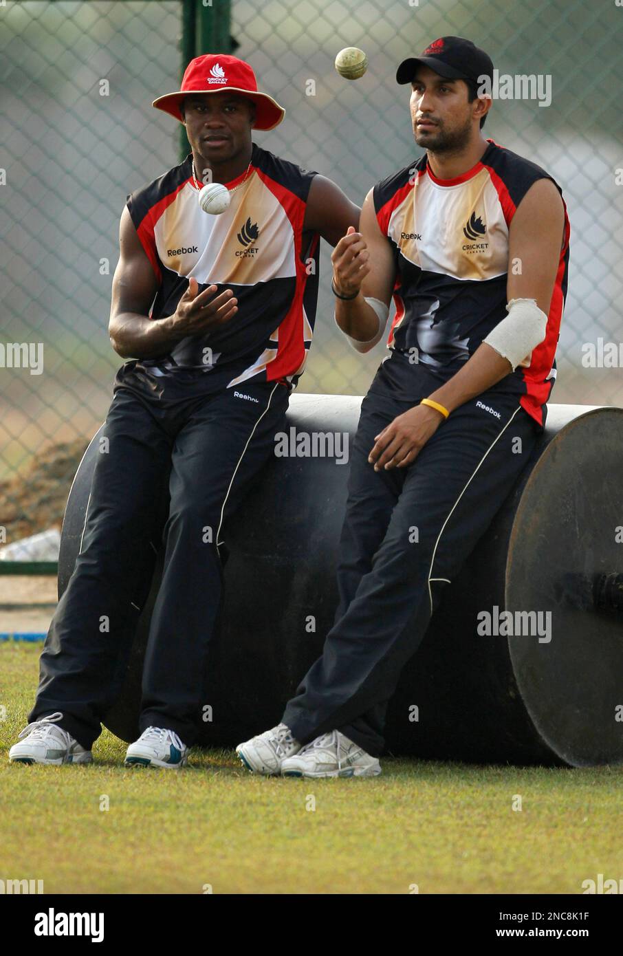 Canada's cricketers Tyson Gordon, left, and Ambhir Hansra rest during a ...