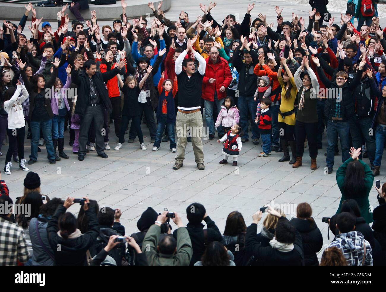 Matthew Harding of the U.S., center, performs dance with his fans and ...