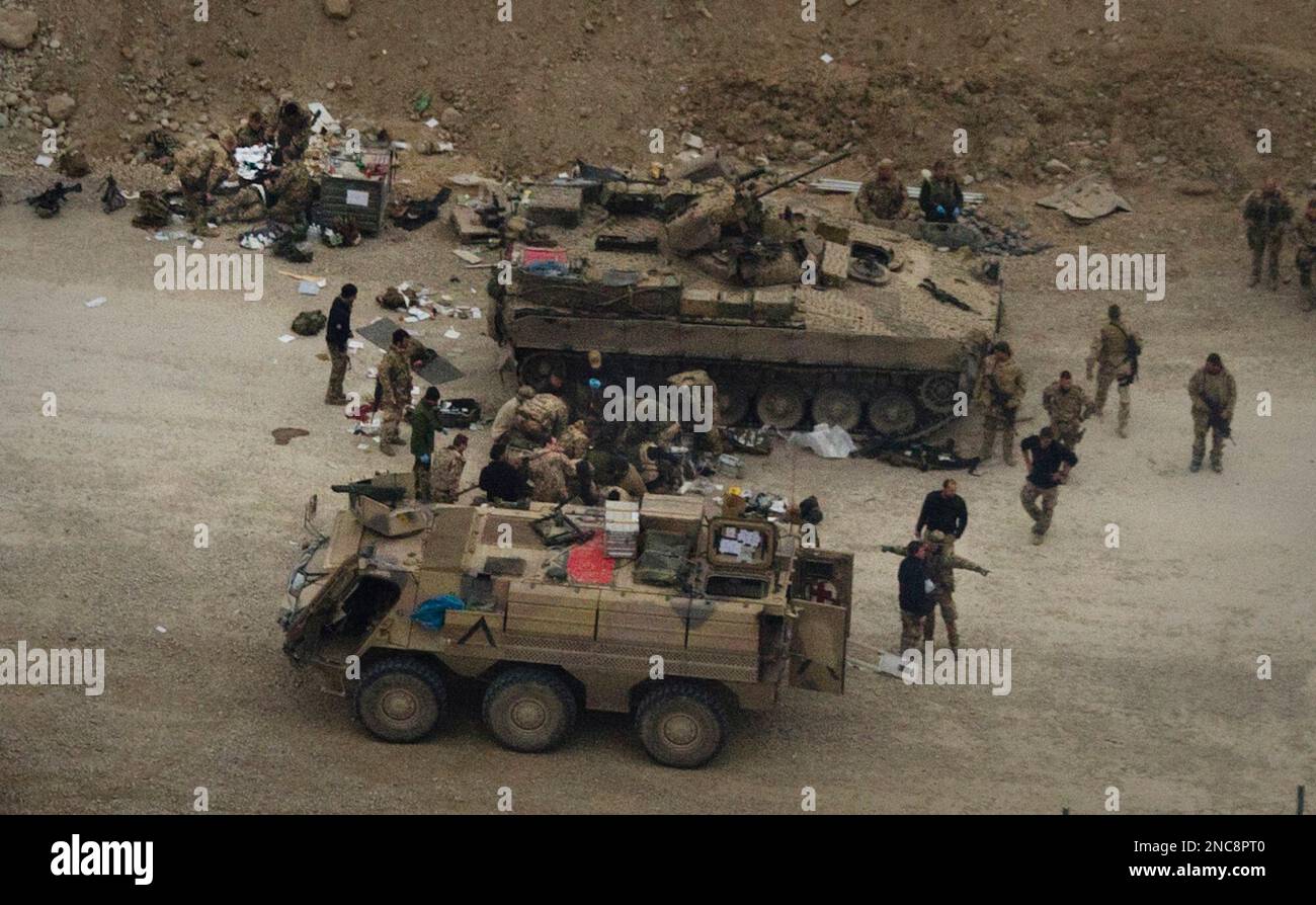 U.S. Army and German soldiers attend to injured German soldiers at the ...