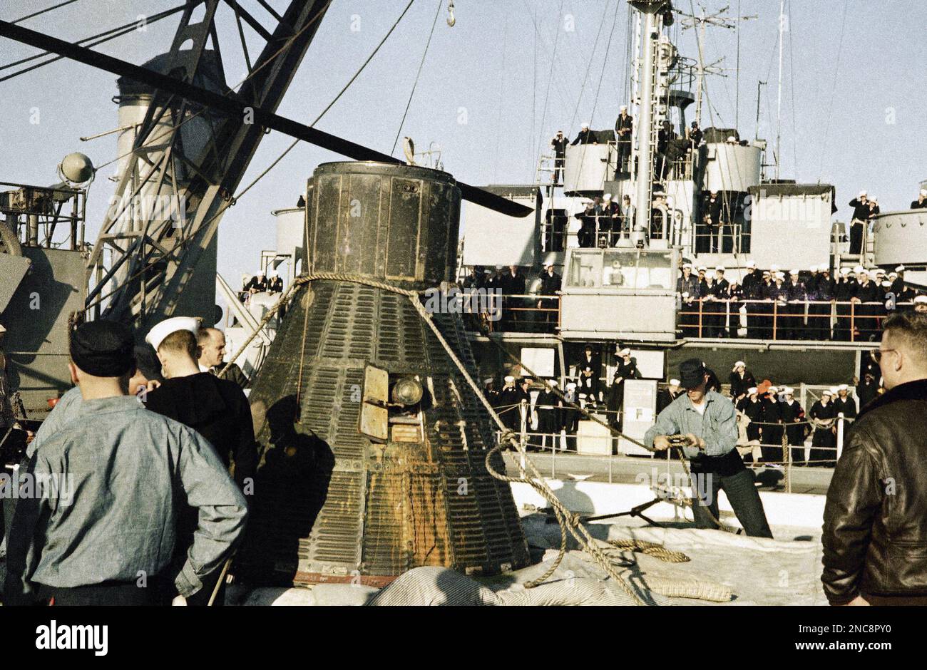 Ham, a chimpanzee, is inside the rocket shown on deck of ship after ...