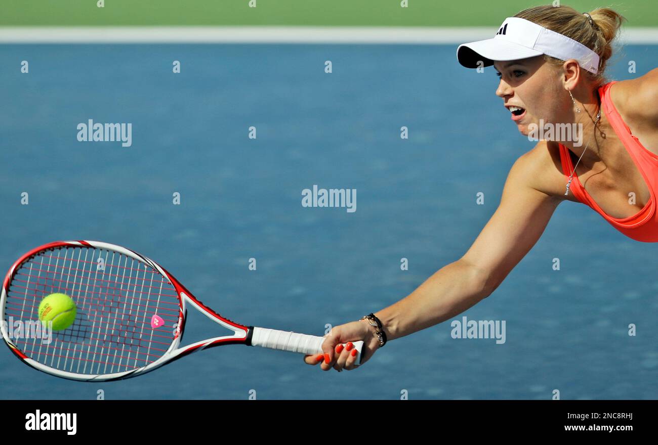 Denmark's Caroline Wozniacki returns the ball to Shahar Peer from ...