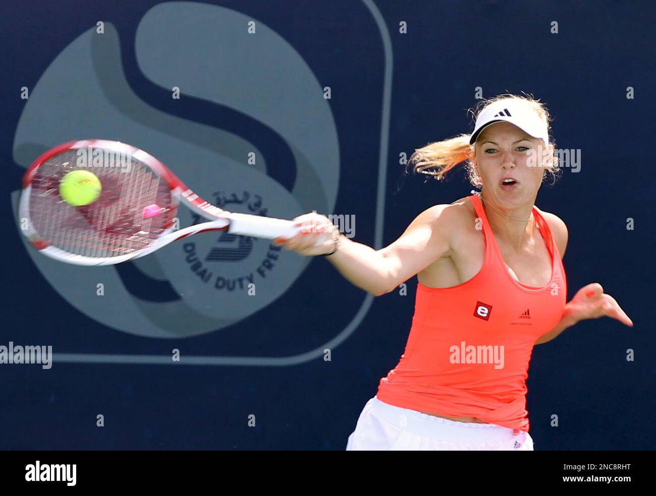 Denmark's Caroline Wozniacki returns the ball to Israel's Shahar Peer ...