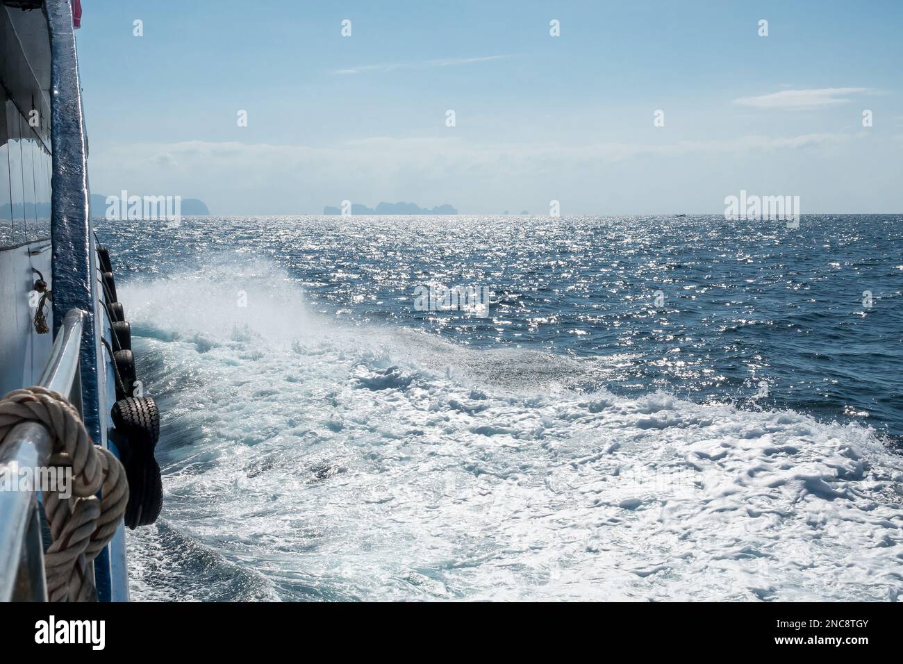 Ocean waves cut by a boat going on full speed under the sunlight Stock ...