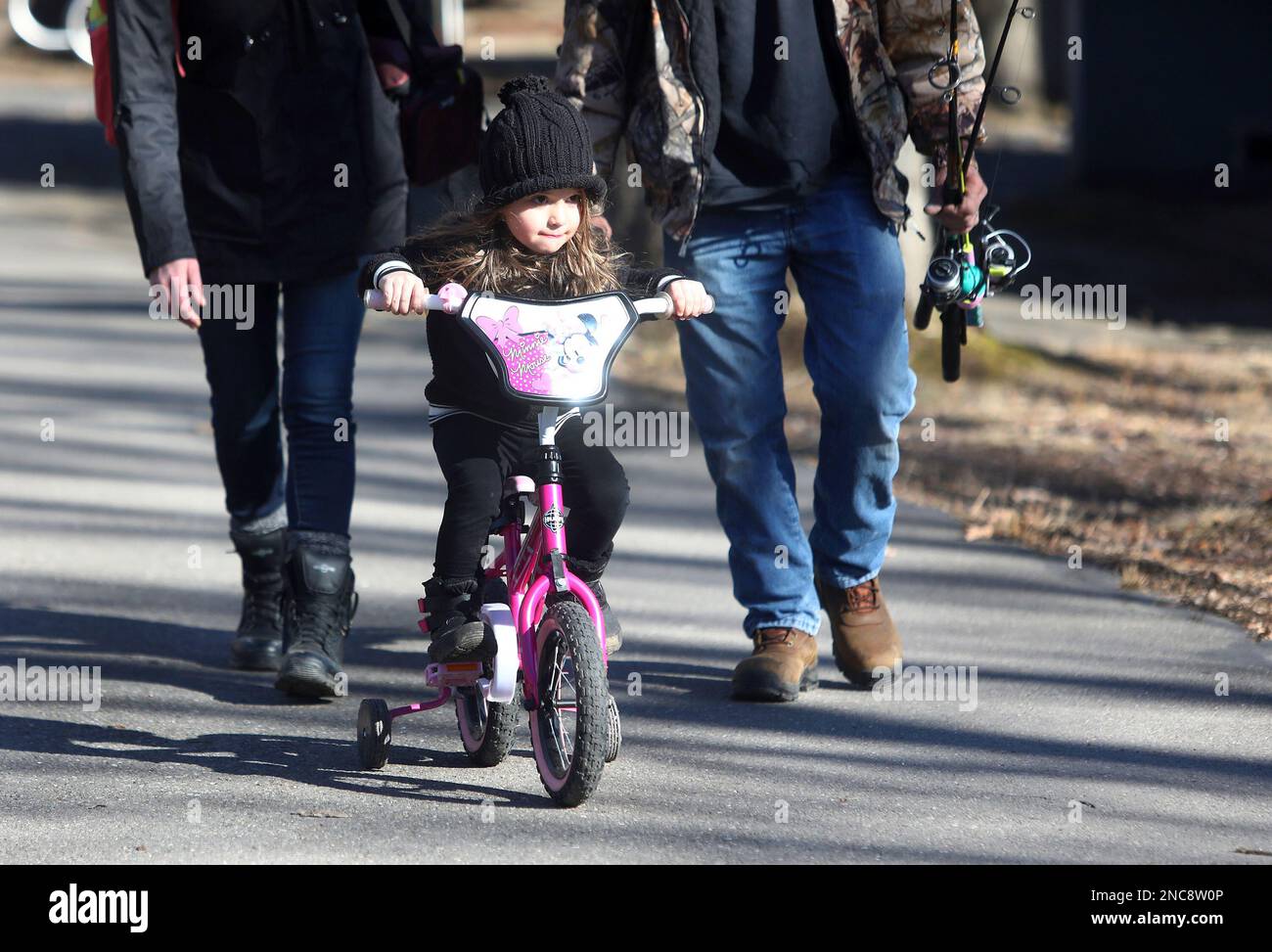 Bell Hunsinger, 4, of Drums rides her bike ahead of her parents Mark ...