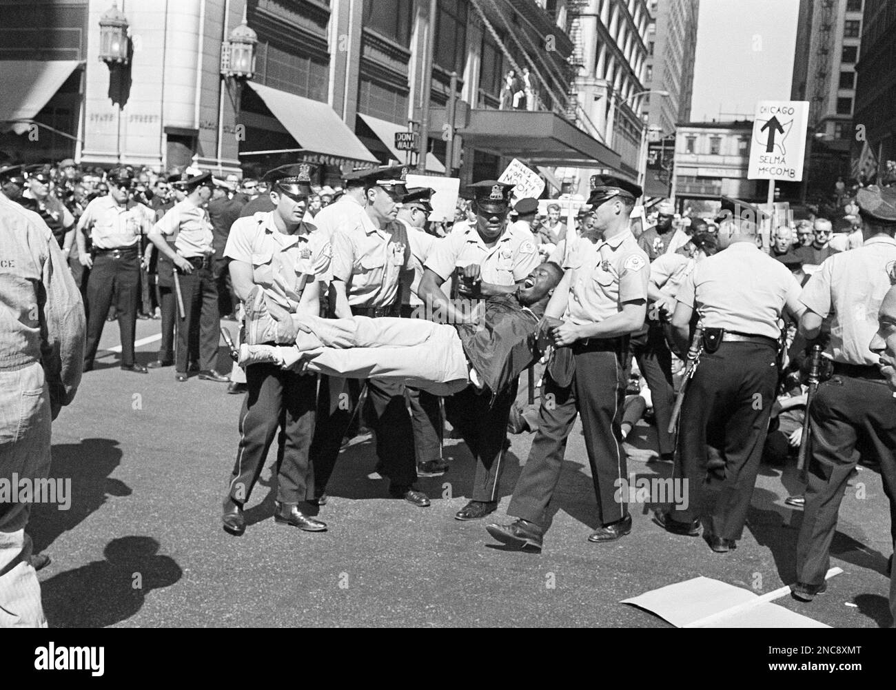 Police carry a demonstrator to a police van after pickets for ...