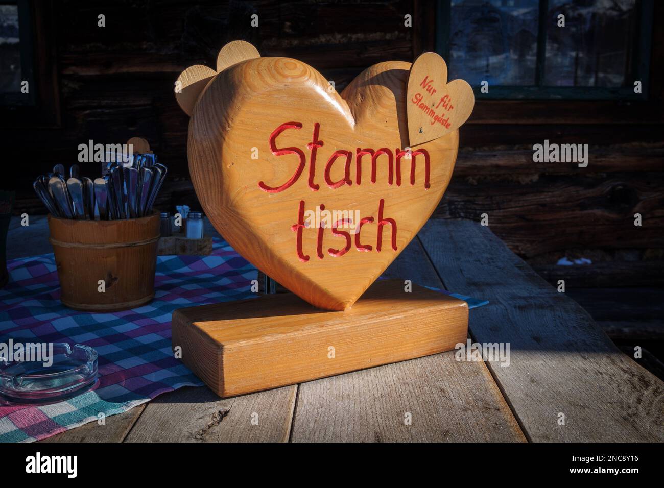 on a heart carved from wood is the german word Stammtisch Stock Photo ...