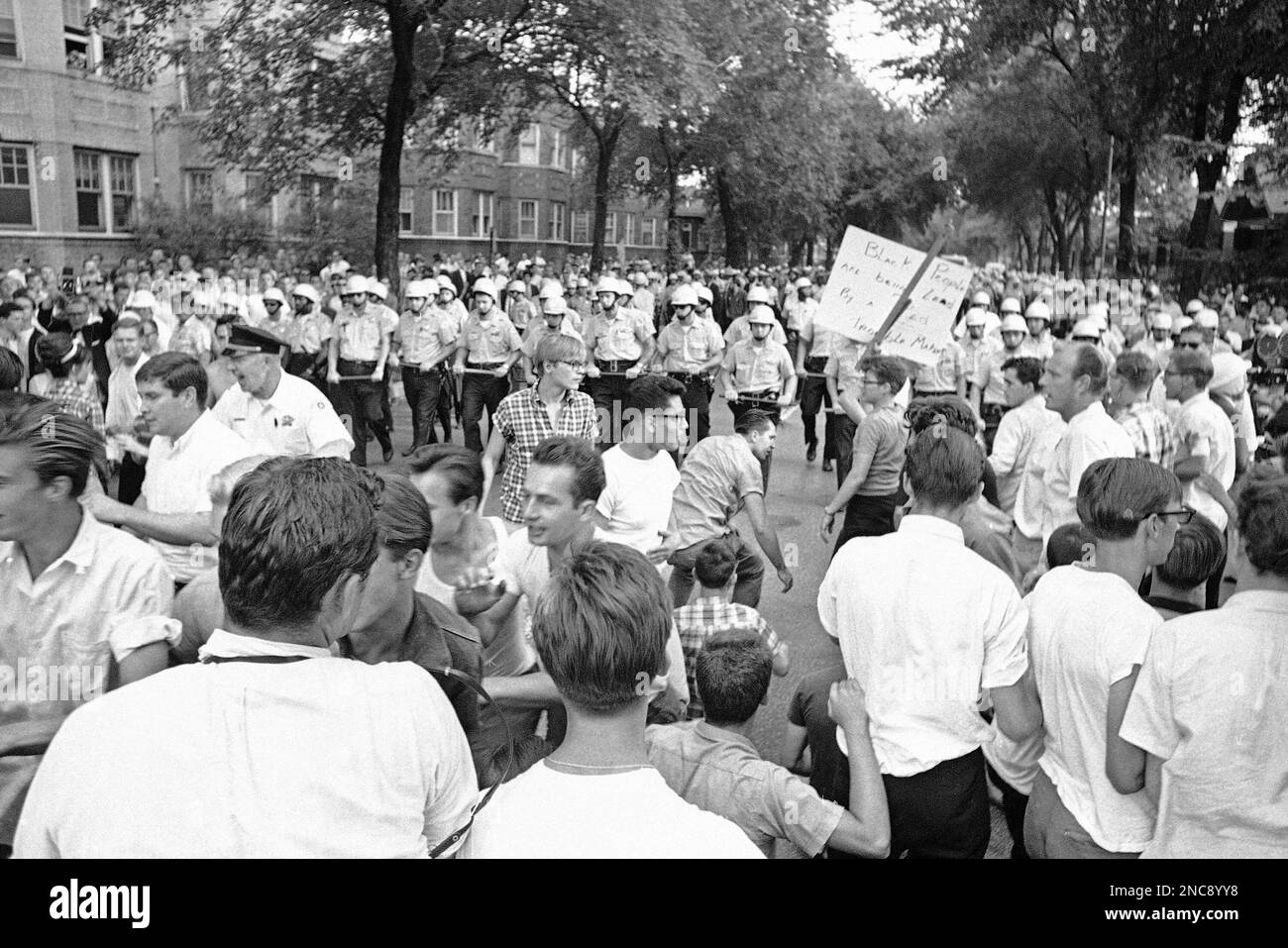 Police walking shoulder-to-shoulder clearing the street of hecklers in ...
