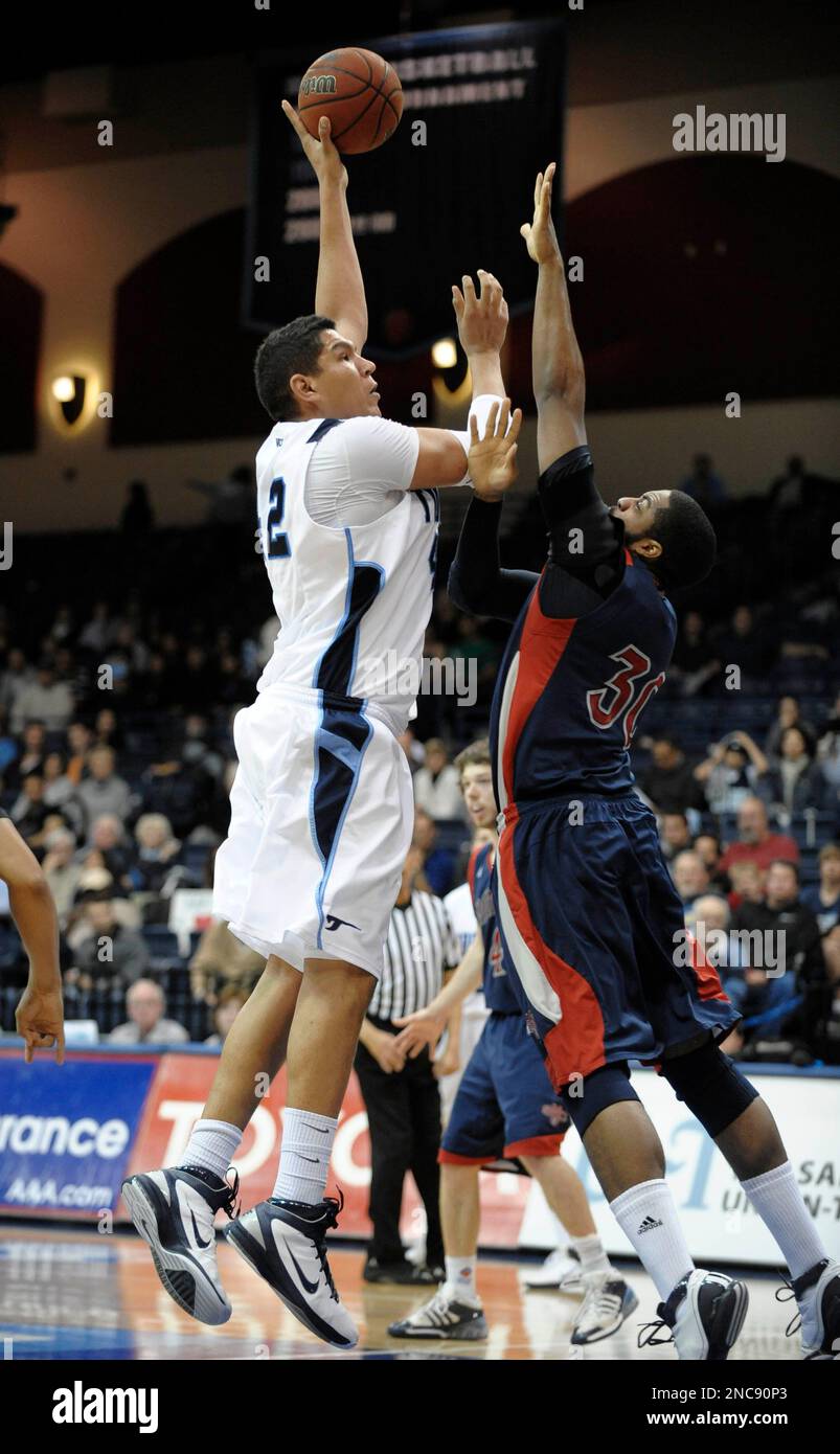 San Diego's Chris Gabriel, left, shoots over Saint Mary's Kenton Walker ...