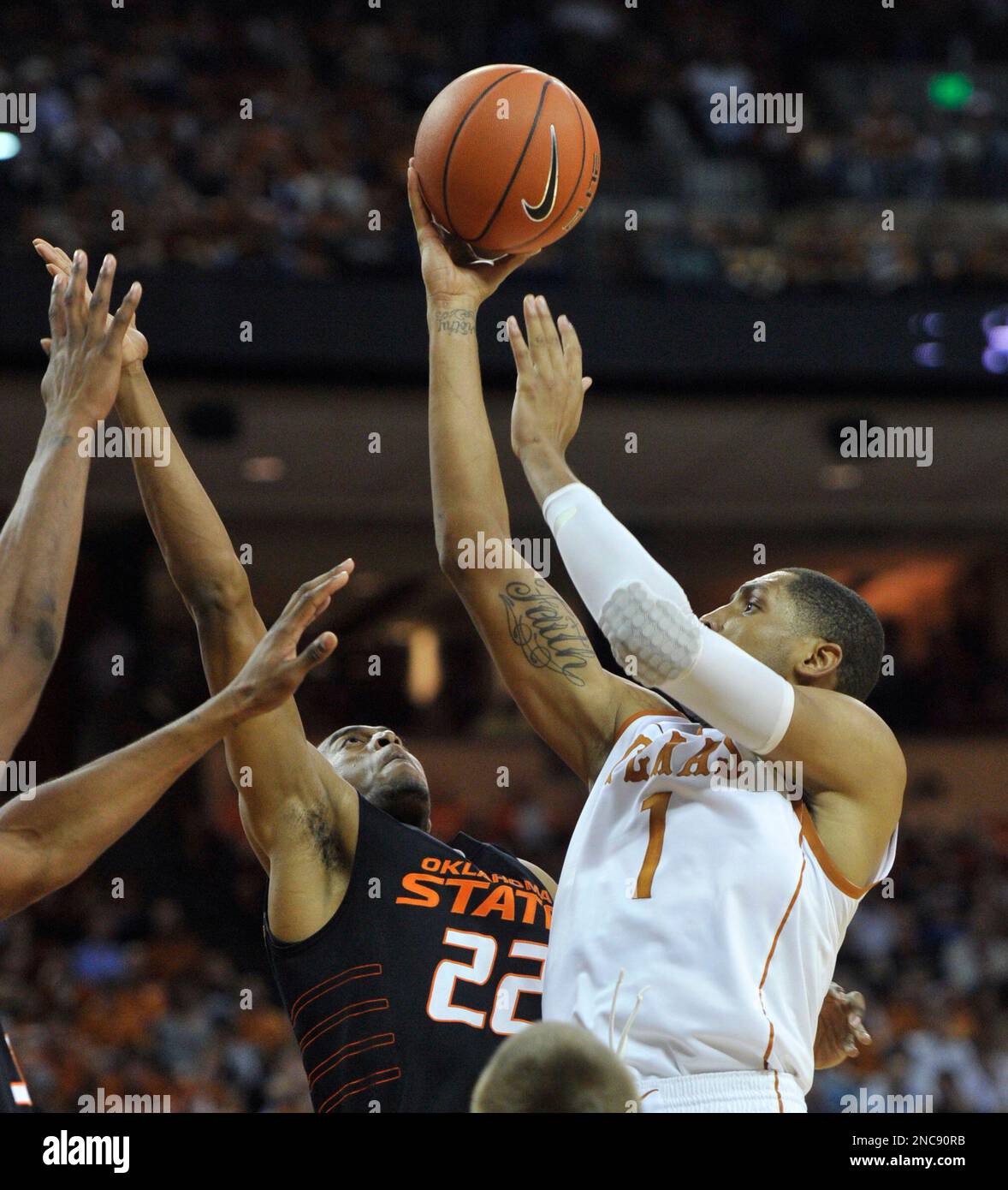 Texas forward Gary Johnson, right, goes up over Oklahoma State guard ...