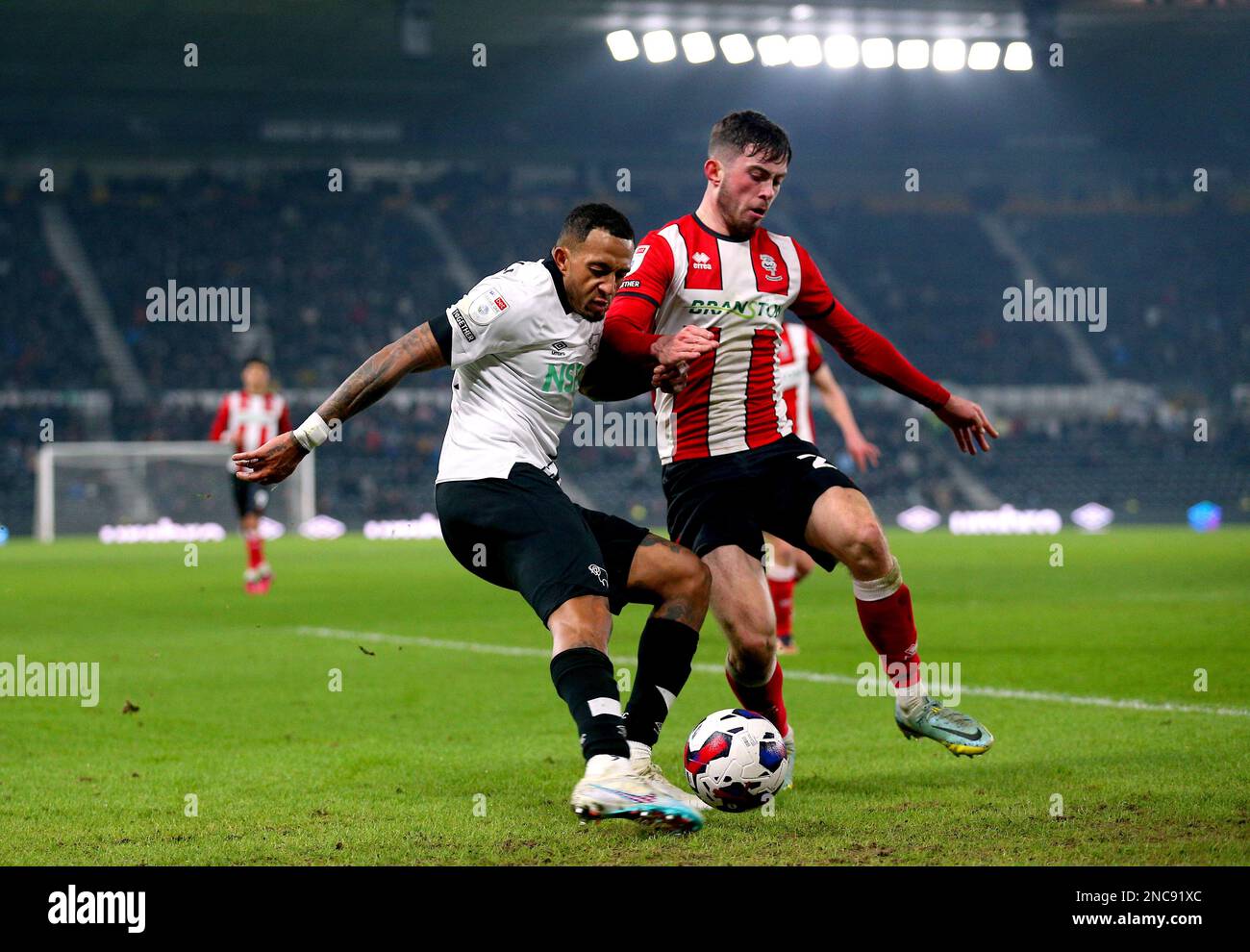 Derby County's Nathaniel Mendez-Laing (left) and Lincoln City's Sean ...