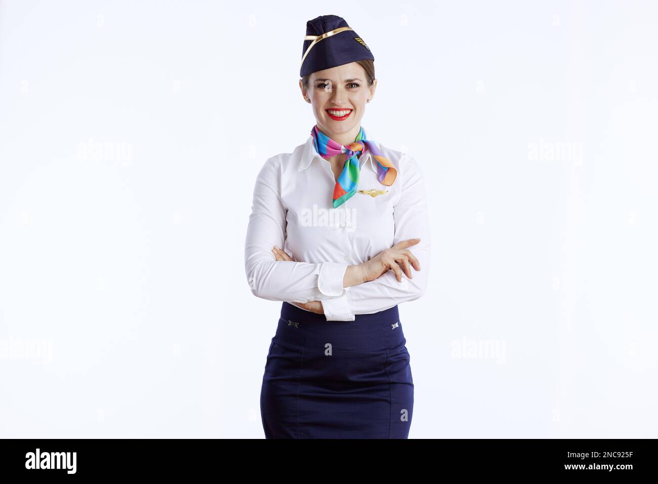 smiling stylish air hostess woman against white background in uniform ...