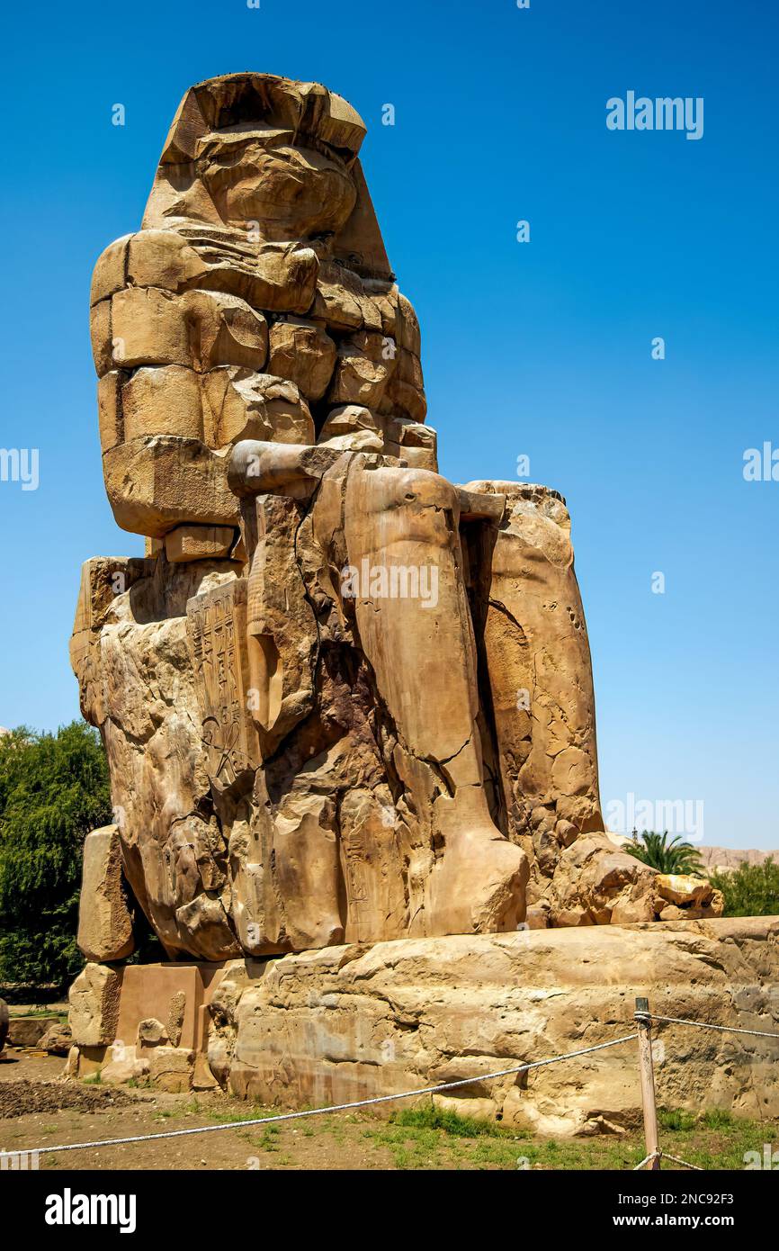Luxor, Egypt. Colossi of Memnon are two massive stone statues of the ...