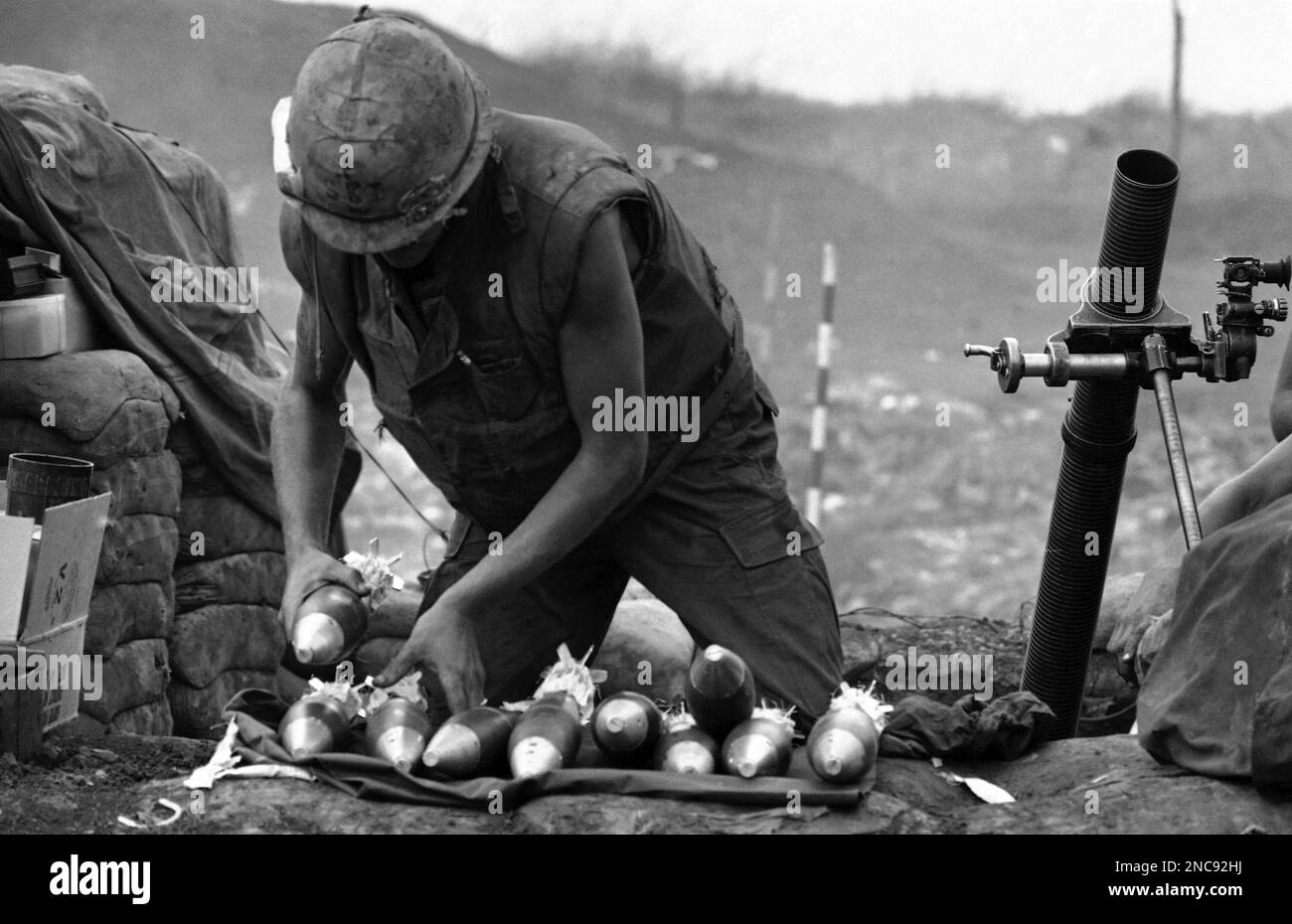 U.S. Marine Mortarman adjusts his 81mm rounds on lip of sandbagged ...