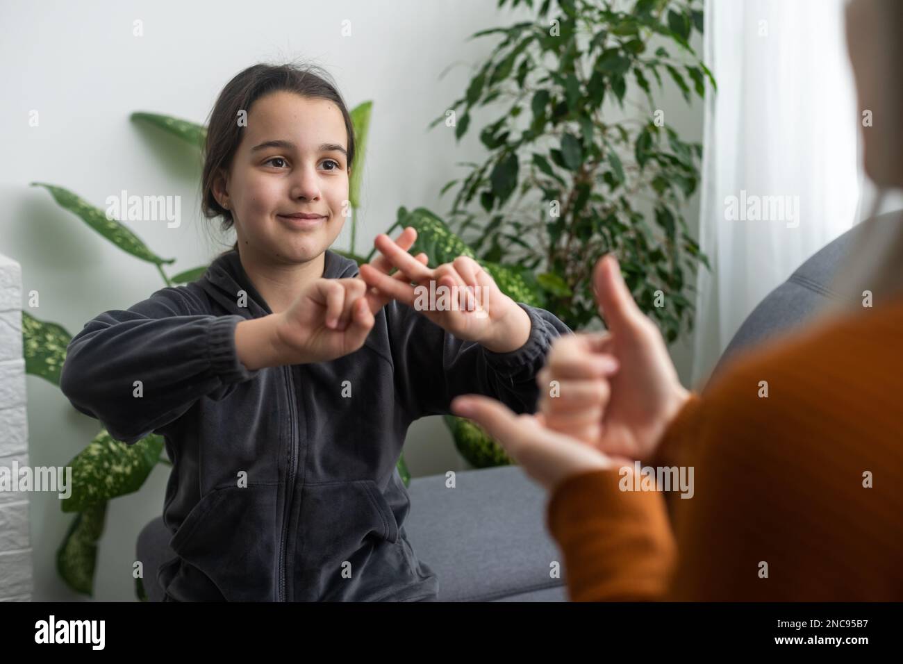 Small Caucasian teen girl child do articulation exercises with caring ...