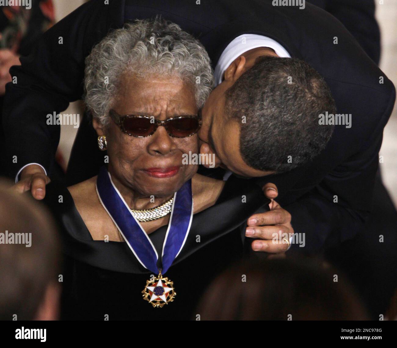President Barack Obama kisses author and poet Maya Angelou after ...