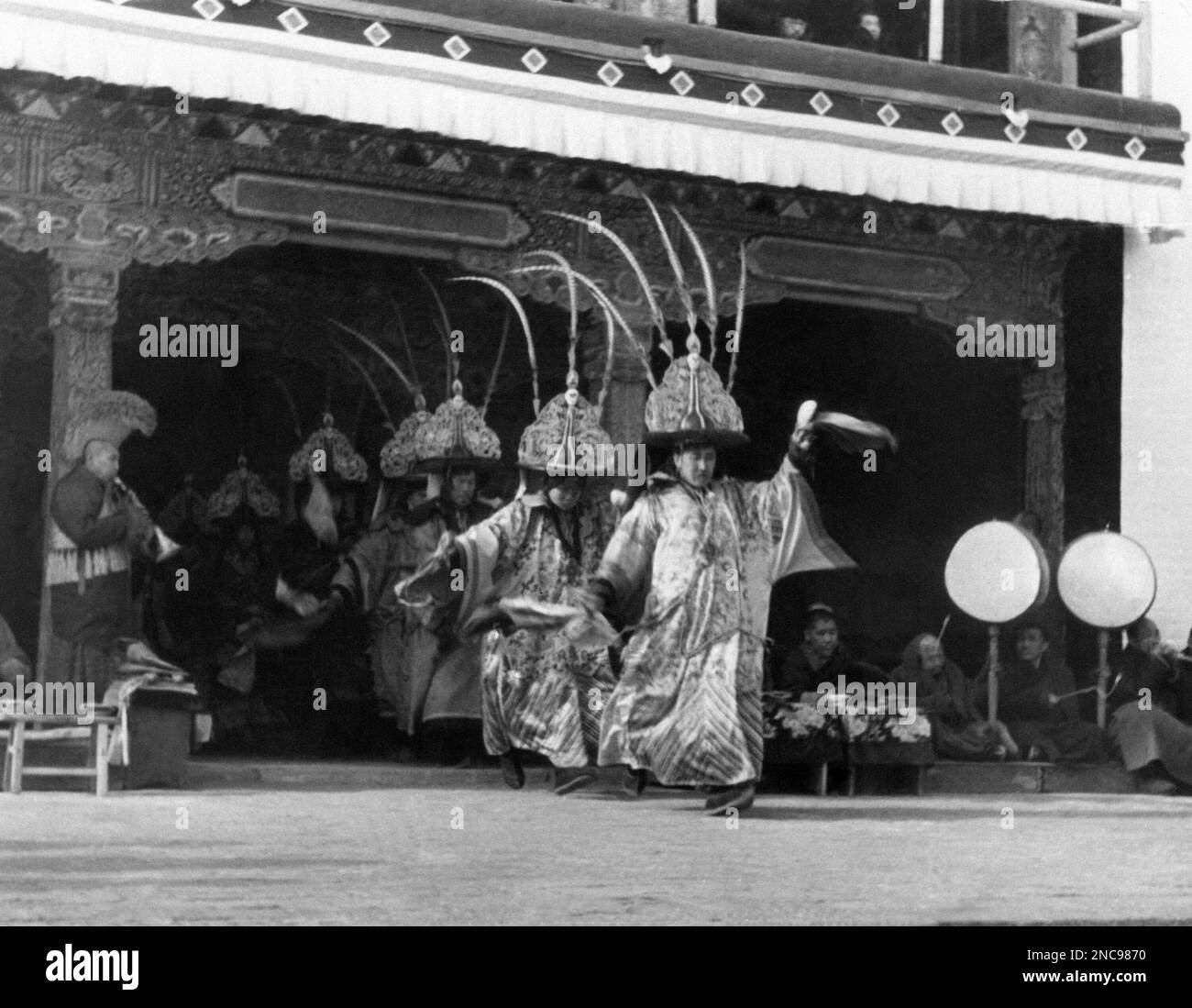 Mongolian priests clad in medieval robes and grotesque, feathered ...