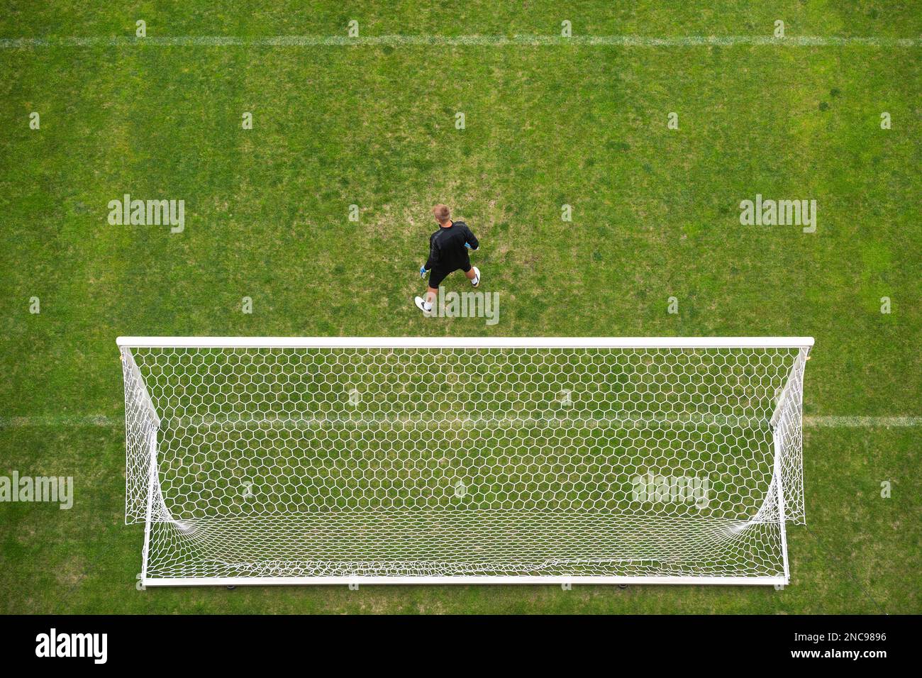 Soccer goalkeeper in front of goal - view from above Stock Photo - Alamy