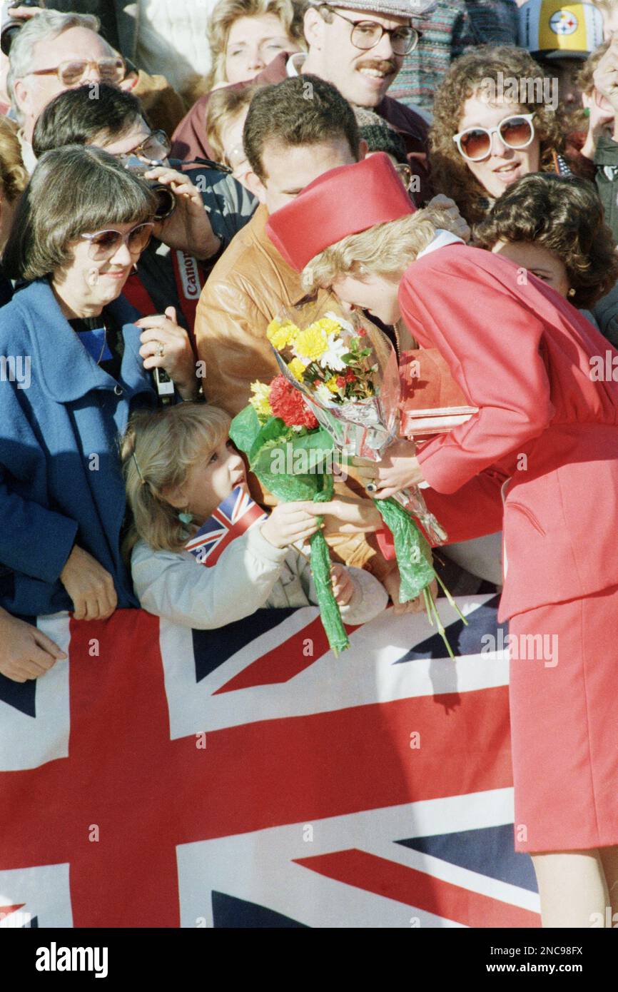 Lady Diana accepts a bouquet of flowers from Nicole Ballangee, as she ...