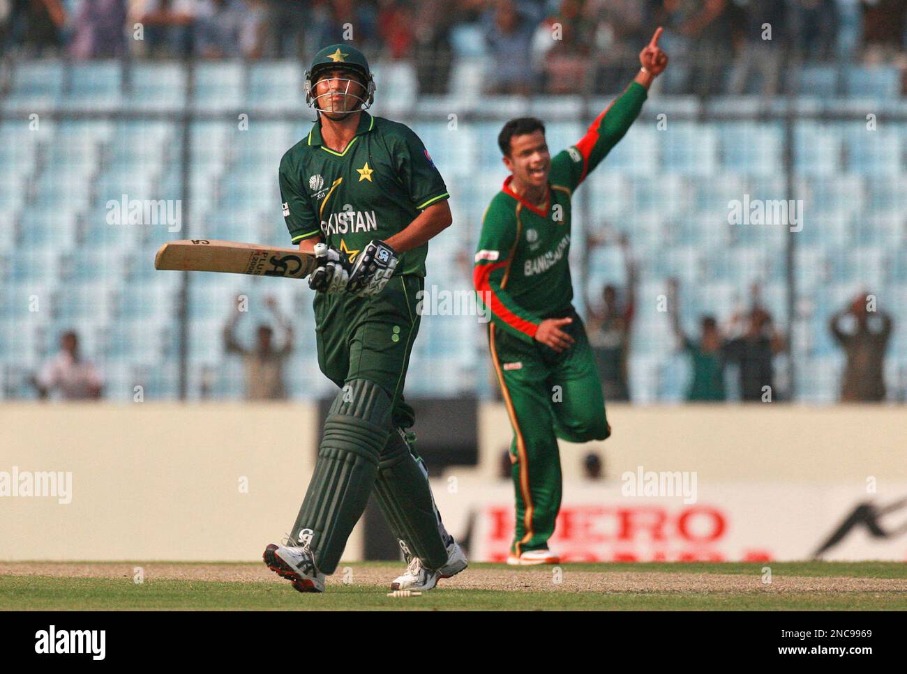 Bangladeshi cricketer Abdur Razzak, right, celebrates the dismissal of ...