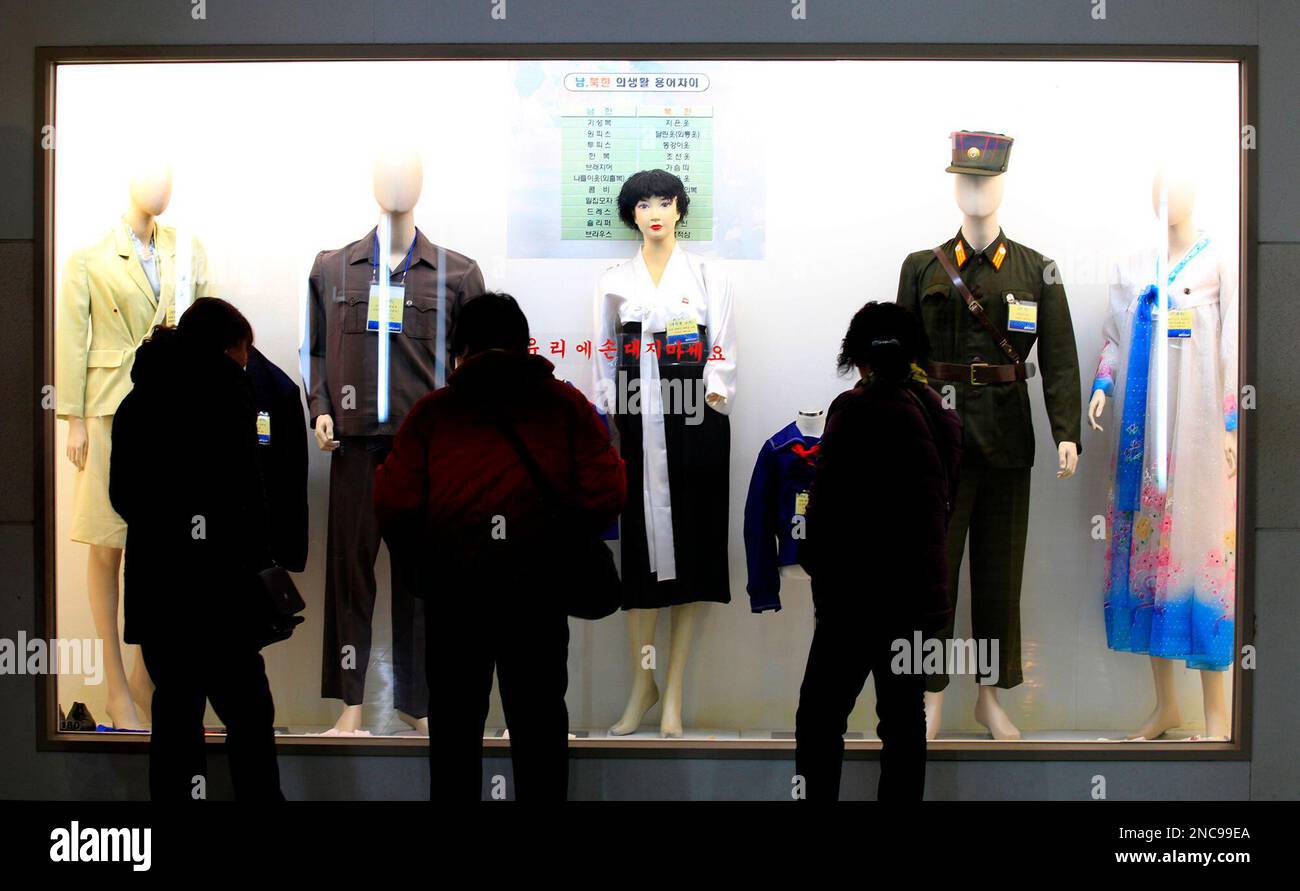 Visitors look at North Korean clothes at a unification observation post ...