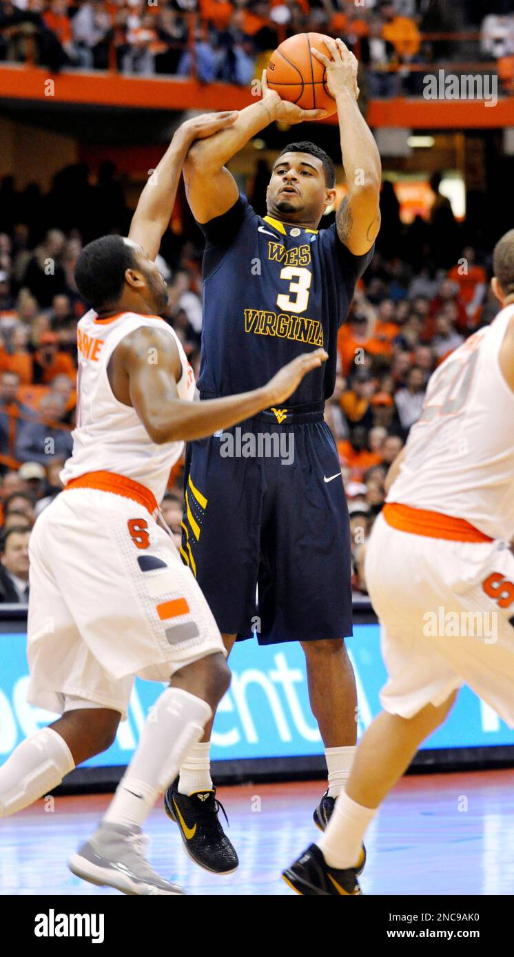 West Virginia's Casey Mitchell shoots over Syracuse's Scoop Jardine ...