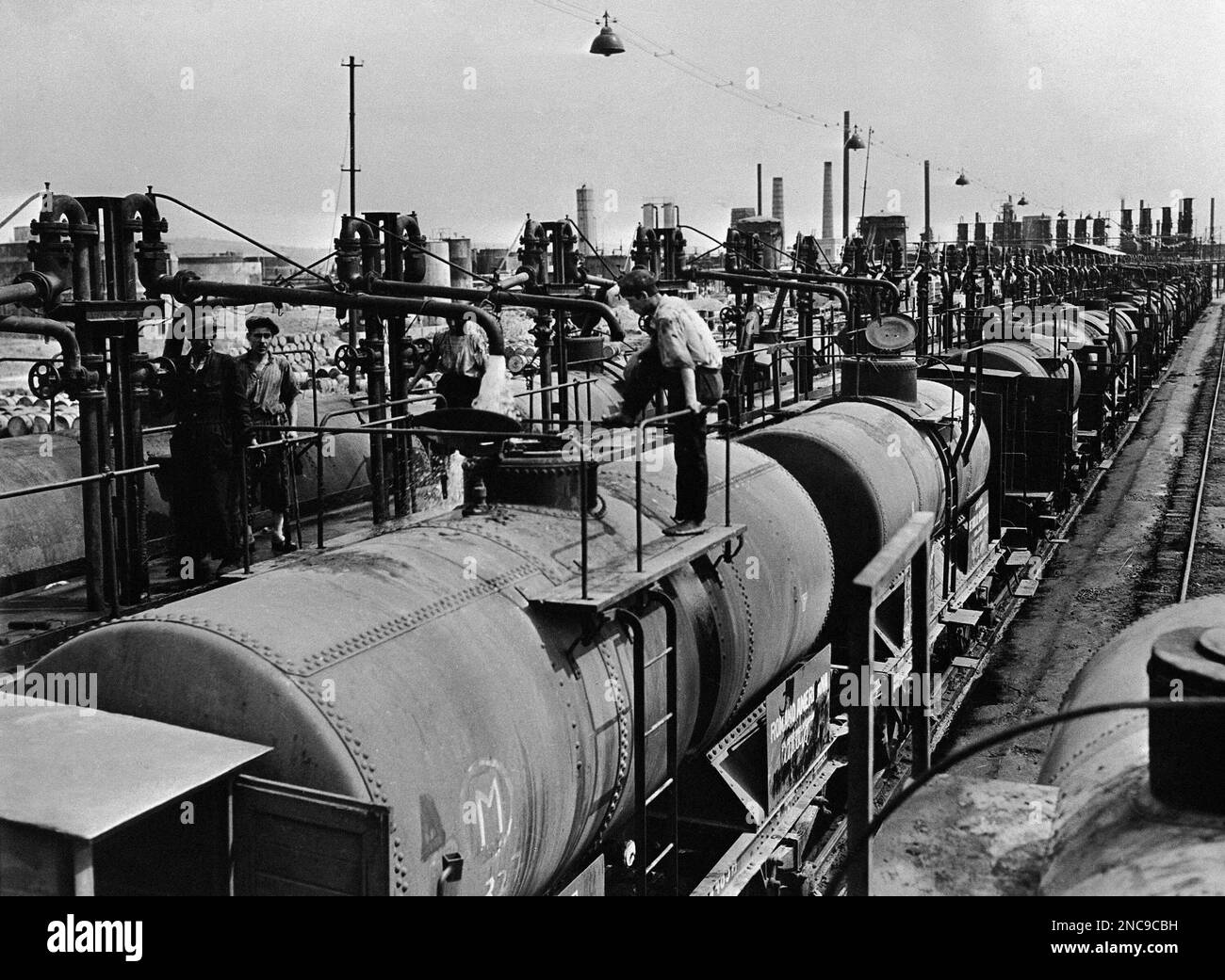 A railway runs right through the oil refineries at Ploiesti, Romania on ...