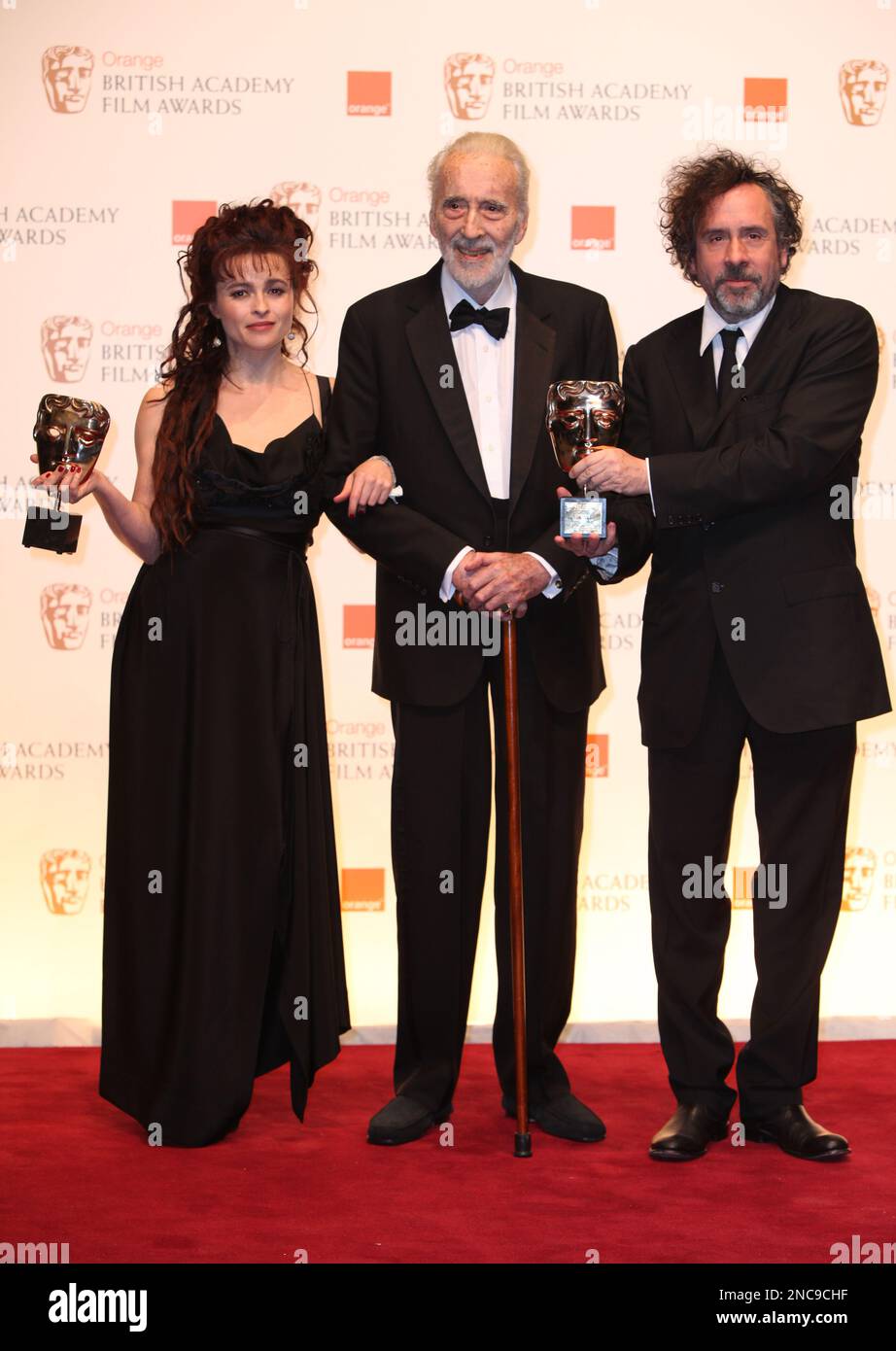 Christopher Lee, center, poses with Tim Burton, right, holding up Lee's ...