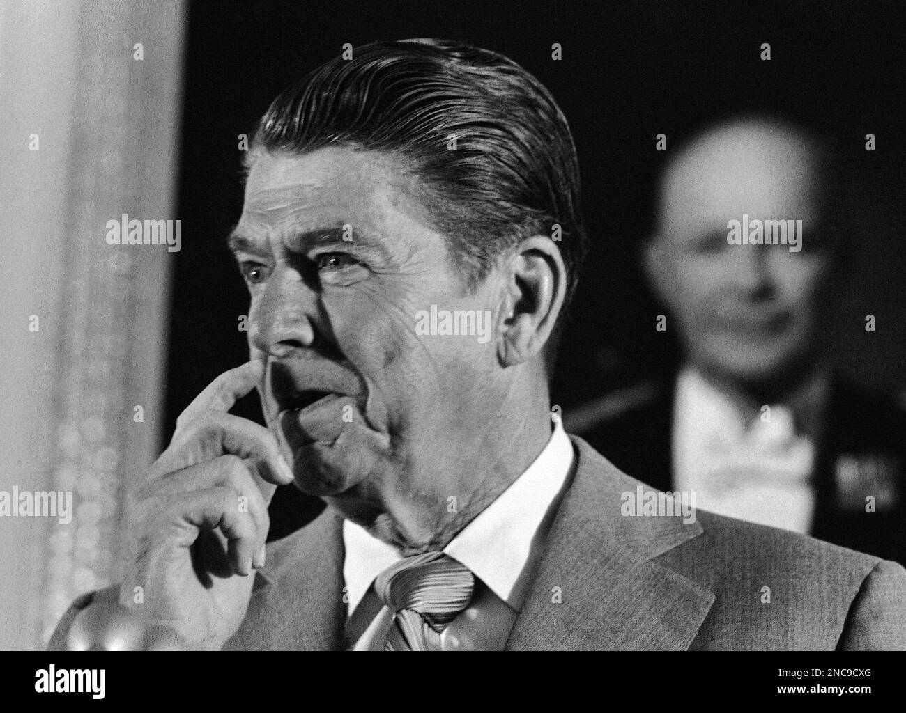 Former California Gov. Ronald Reagan touches finger on his lip as he ...