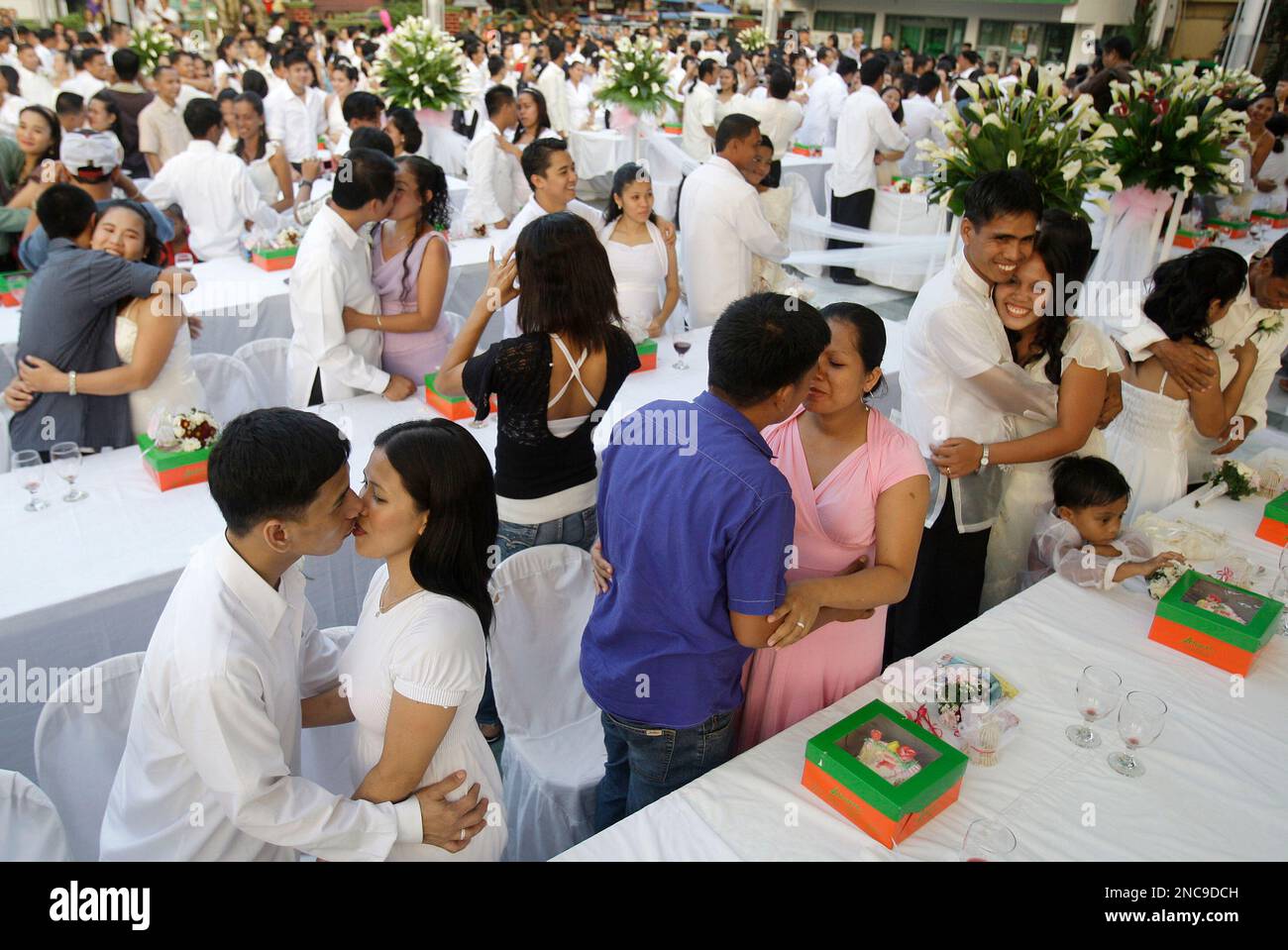 Newly-wed Filipino couples kiss during ceremonies at a mass wedding in ...