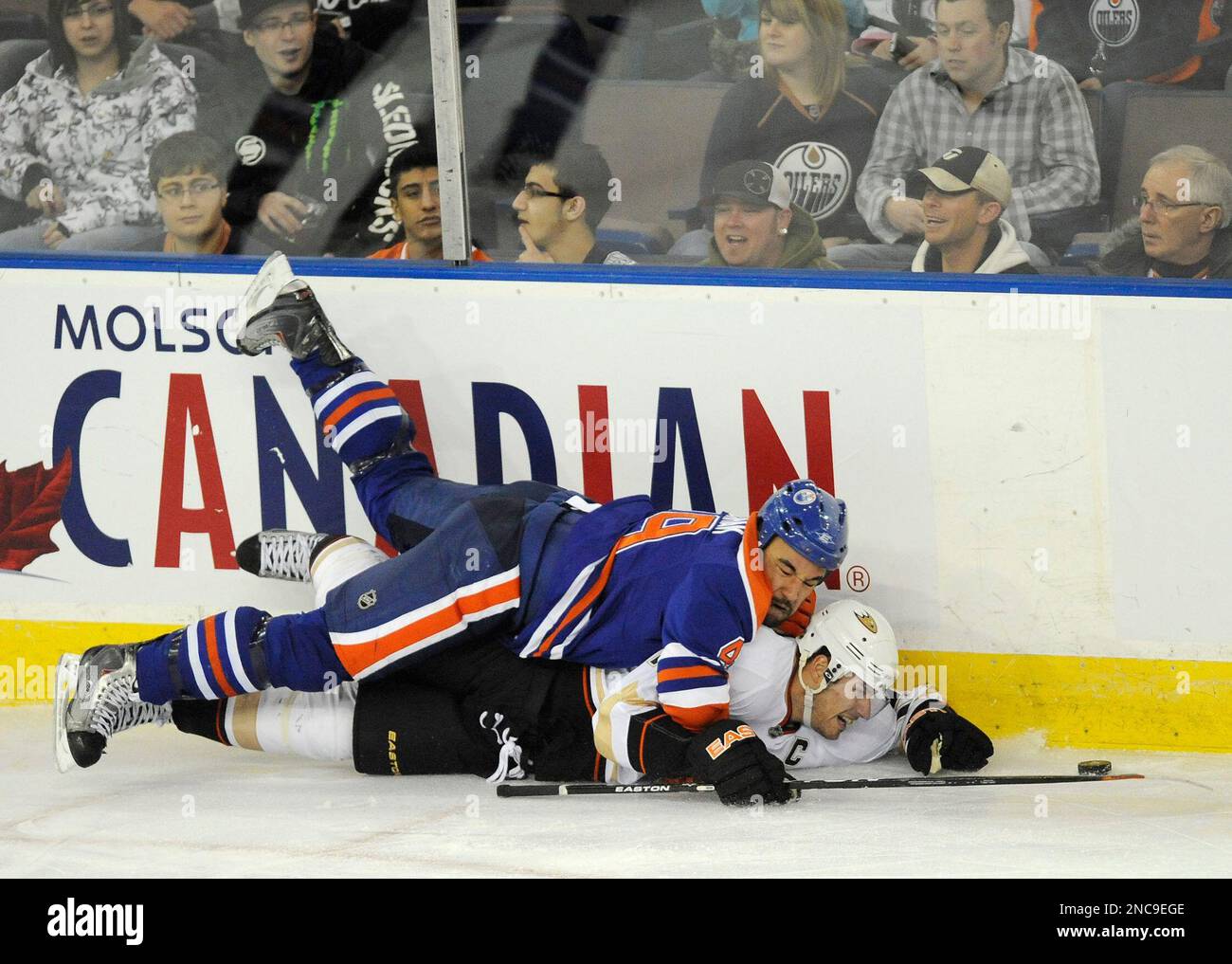 Edmonton Oilers' defenseman Theo Peckham, top, knocks down Anaheim ...