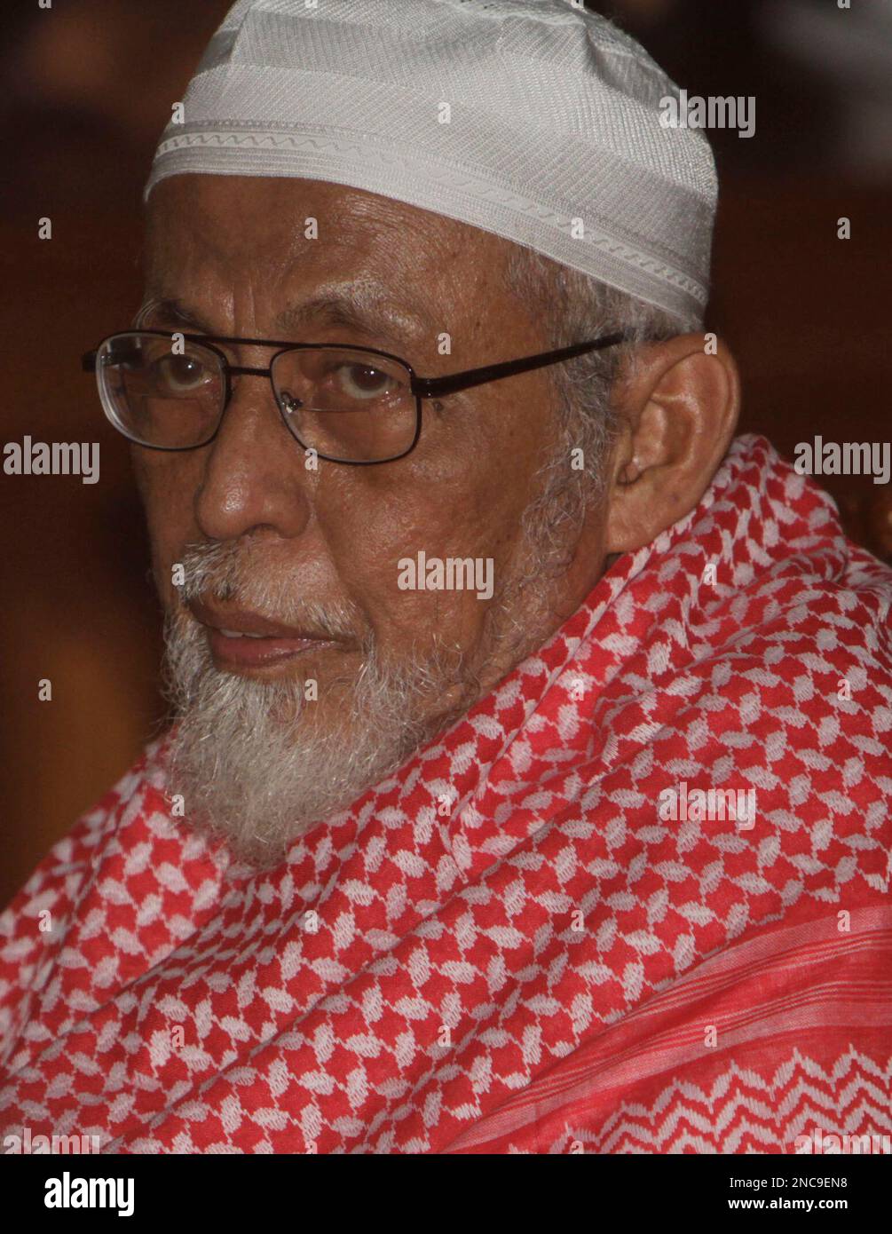 Militant cleric Abu Bakar Bashir sits on the defendant's chair during ...