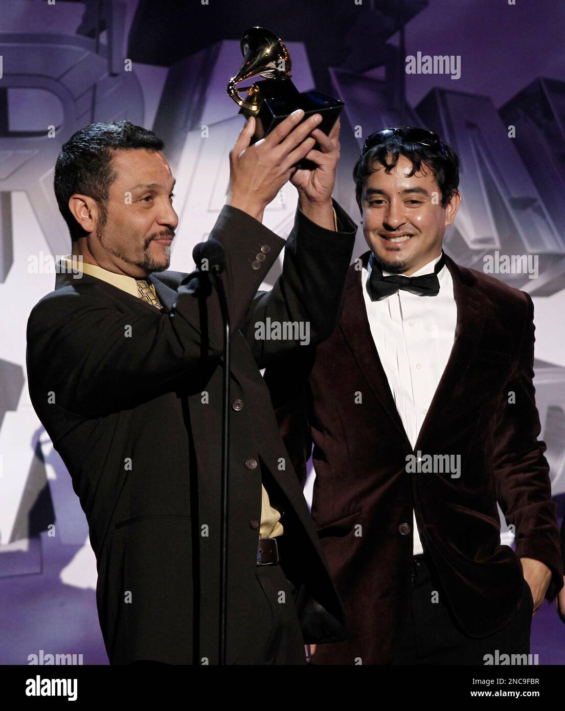 Jose Galeano, left, and Mark Gonzales of Grupo Fantasma accept the ...
