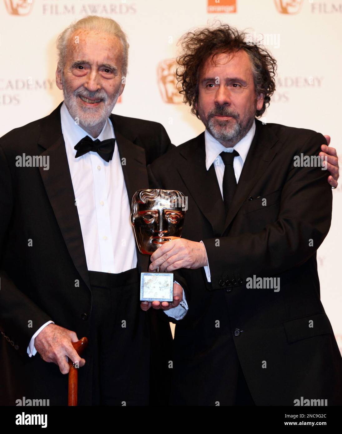 Tim Burton, right, holds up Christopher Lee's Academy Fellowship award ...