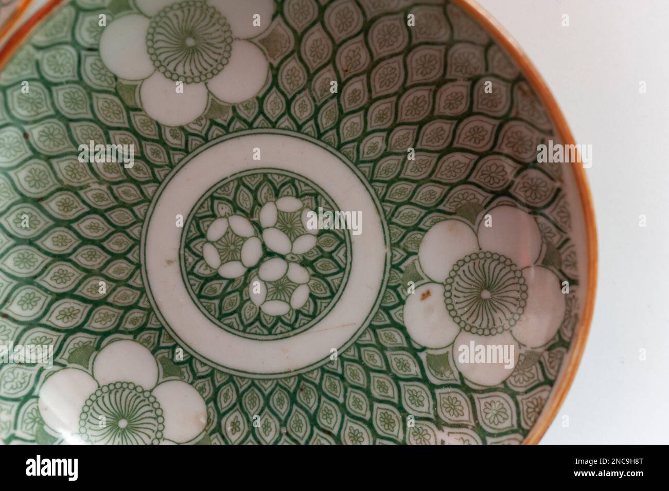 Ume plum blossom patterns on a green and white Japanese inban style ...