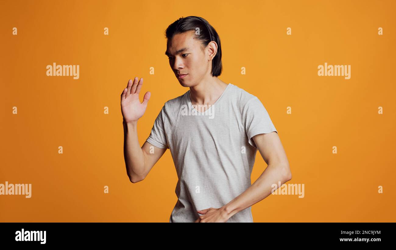 Positive person showing robotic dance moves on camera, acting silly ...