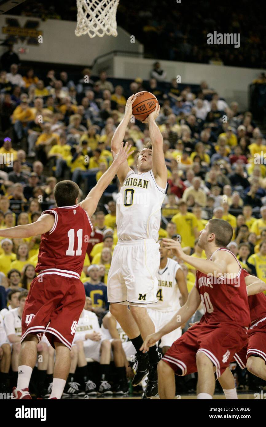 Michigan's Zack Novak (0) takes a shot against Indiana's Daniel Moore ...